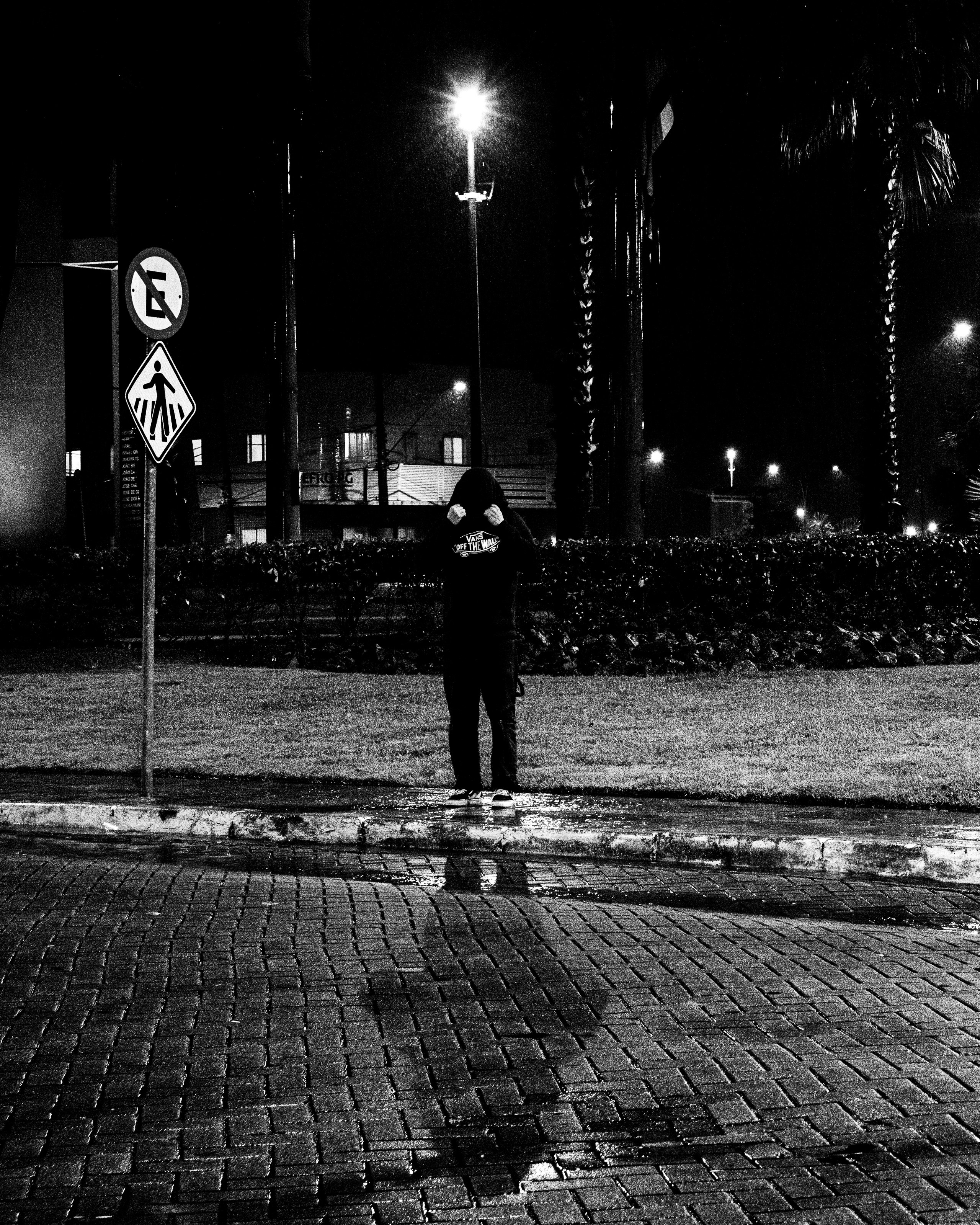 Midnight Silhouette: A solitary figure under streetlight