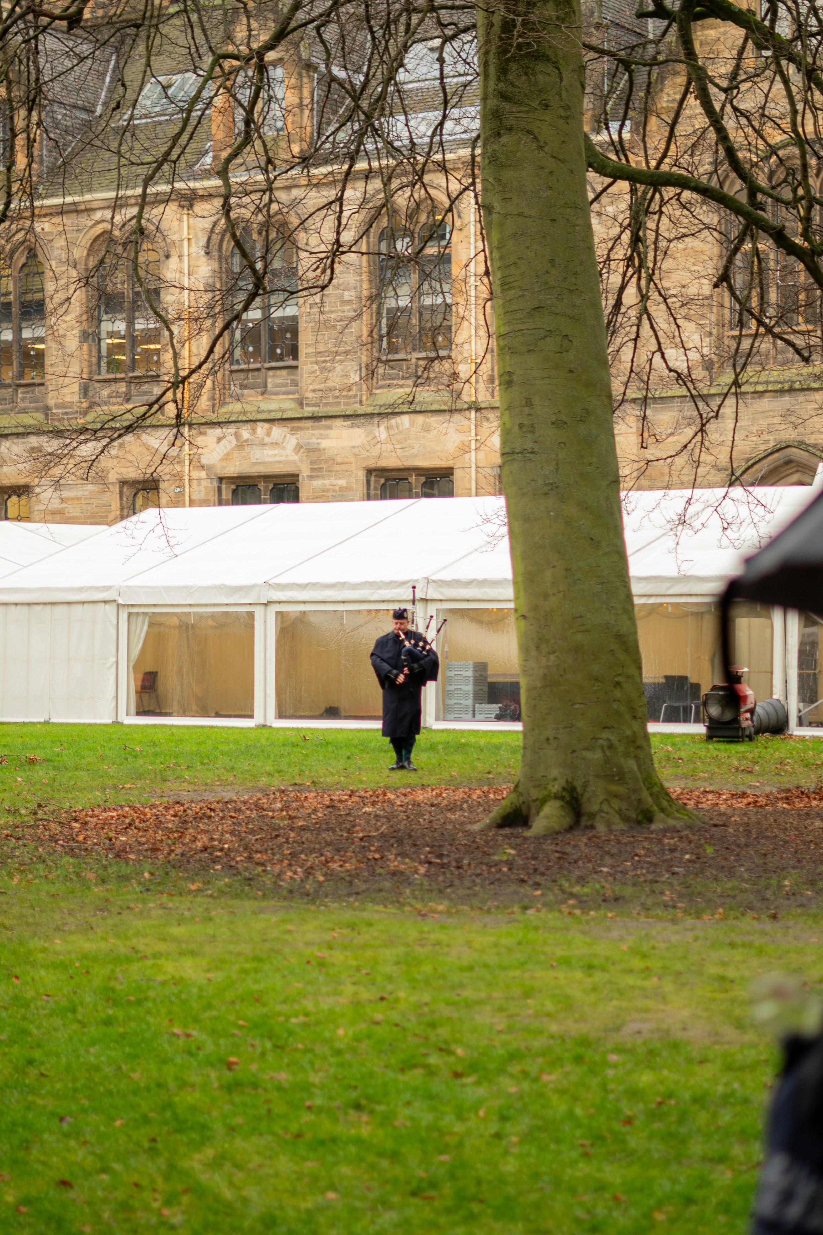 Policeman in a Park: A Gentle Figure by the Tented Pavilion