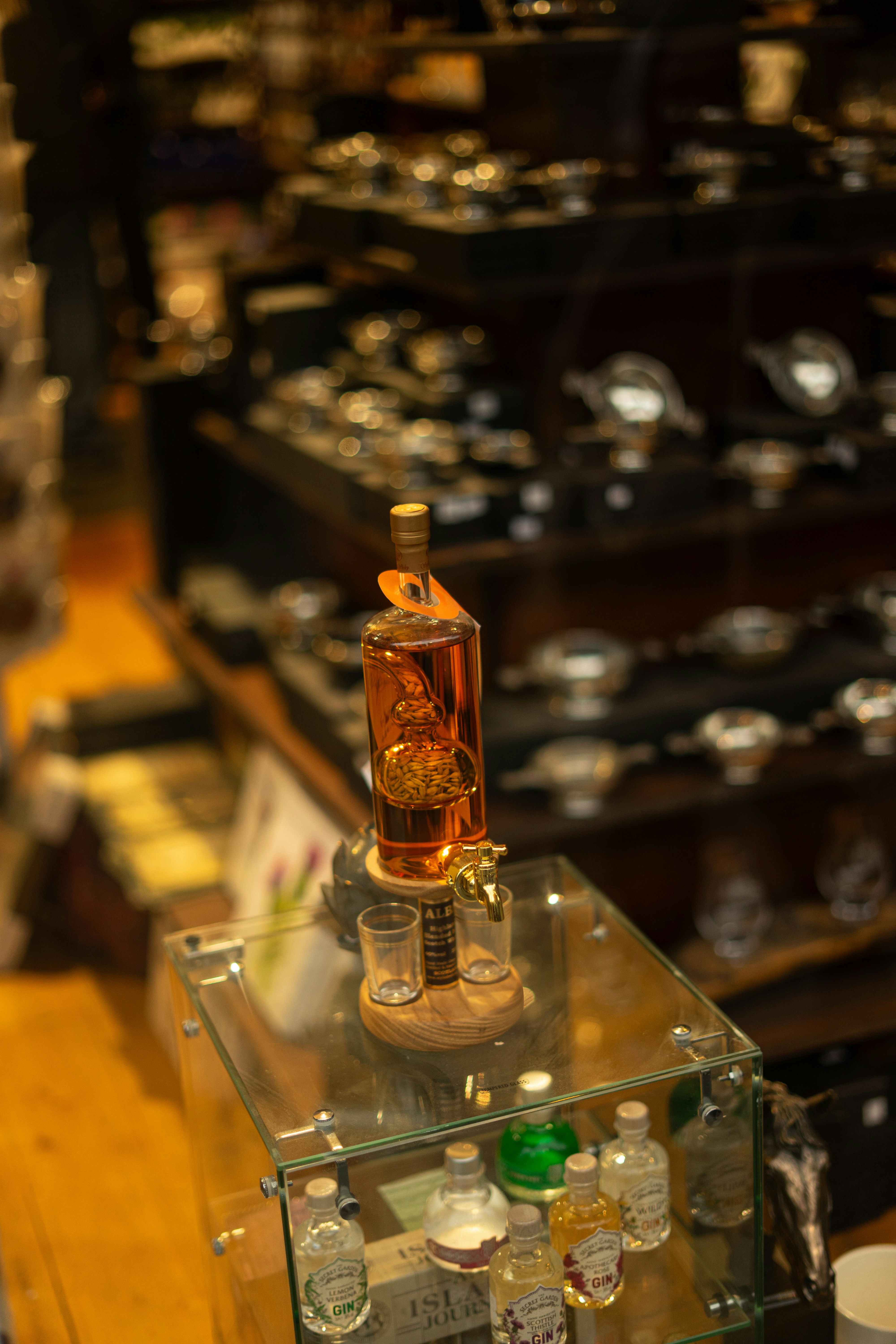 Amber Spirit on Display: Whisky Bottle Crowned by Glass Case