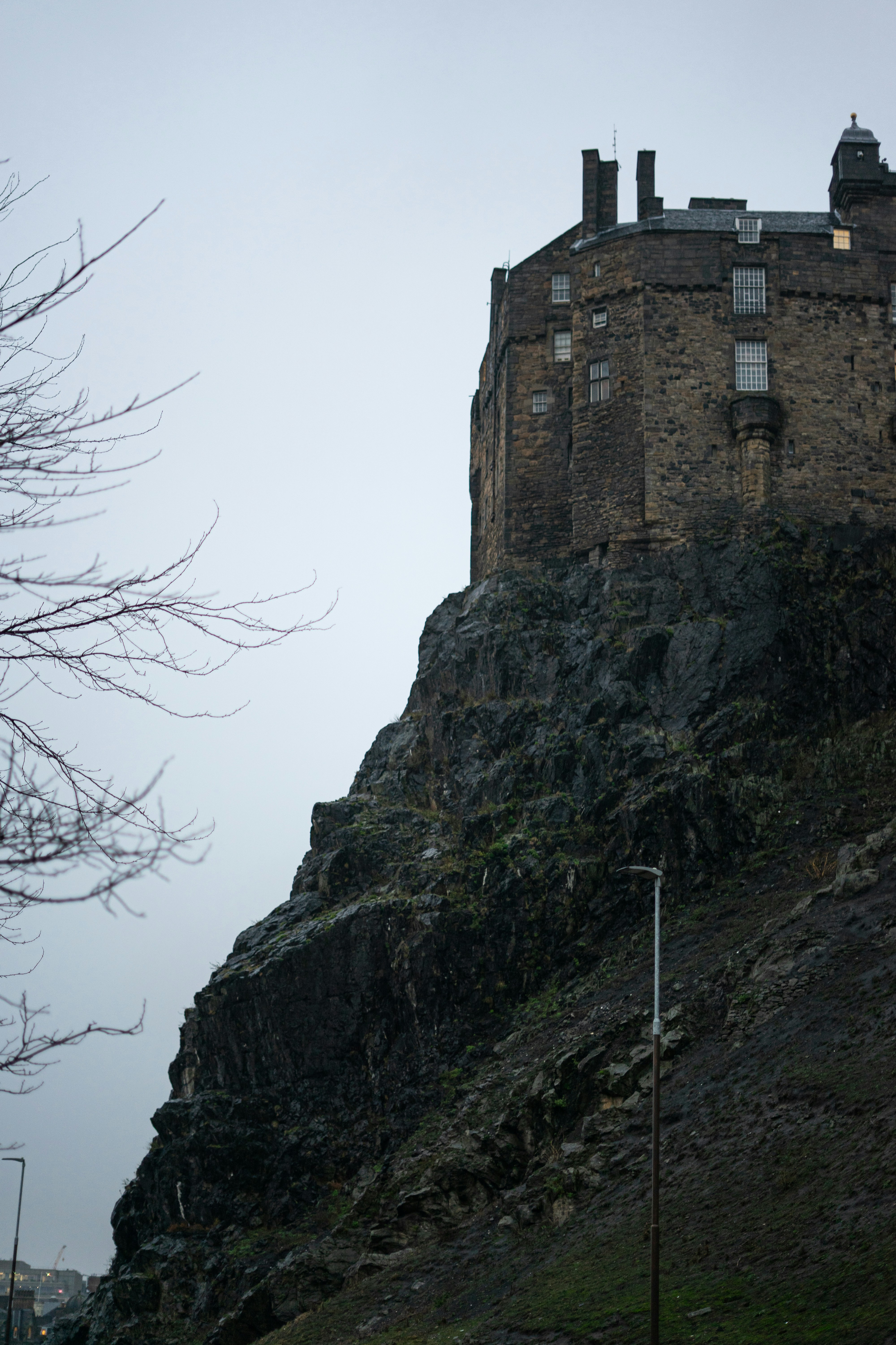 Stone castle perched on a rocky cliffside photo – Free Castle Image on ...