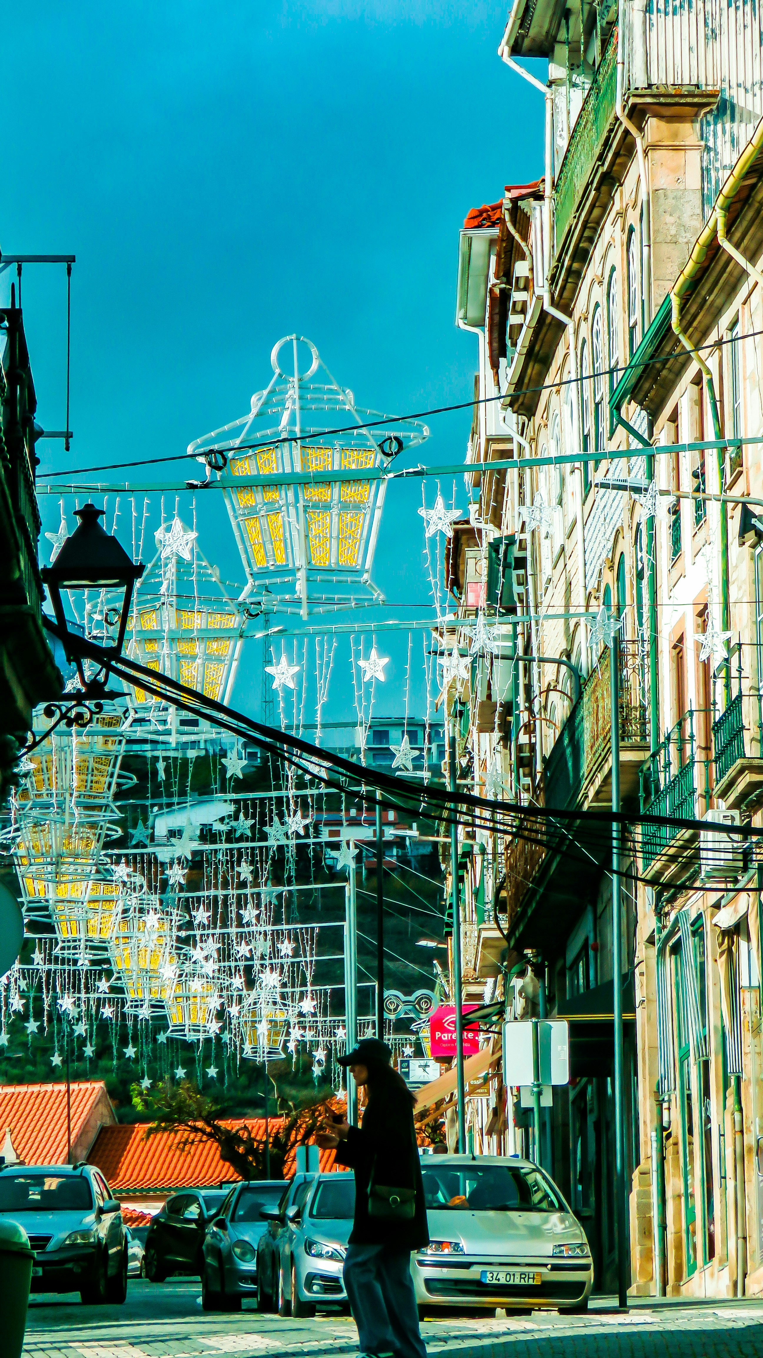 Lanterns and lace on a sunlit Portuguese street