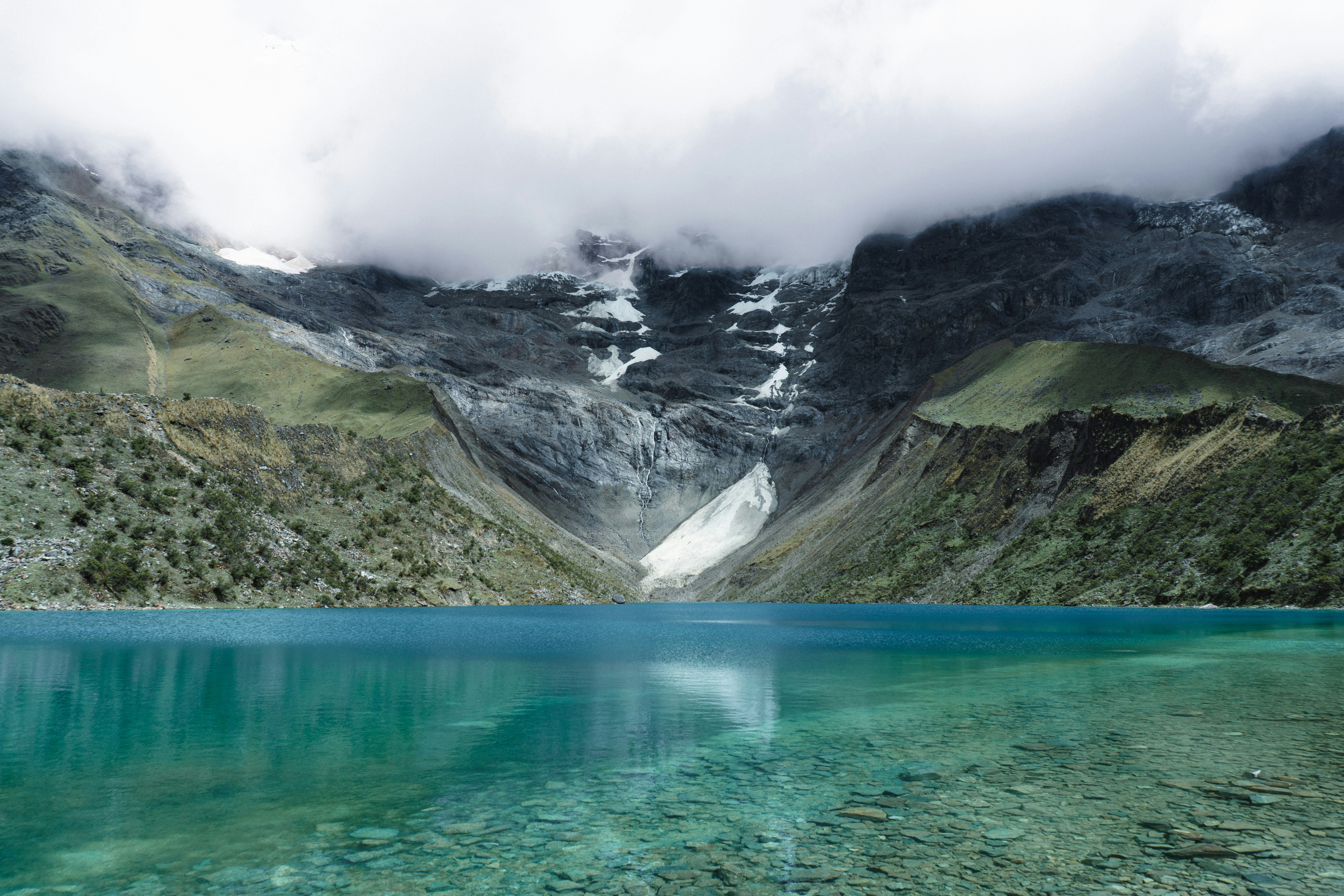 Glacial Gate: Turquoise Lake at the Foot of Cloud-Capped Peaks