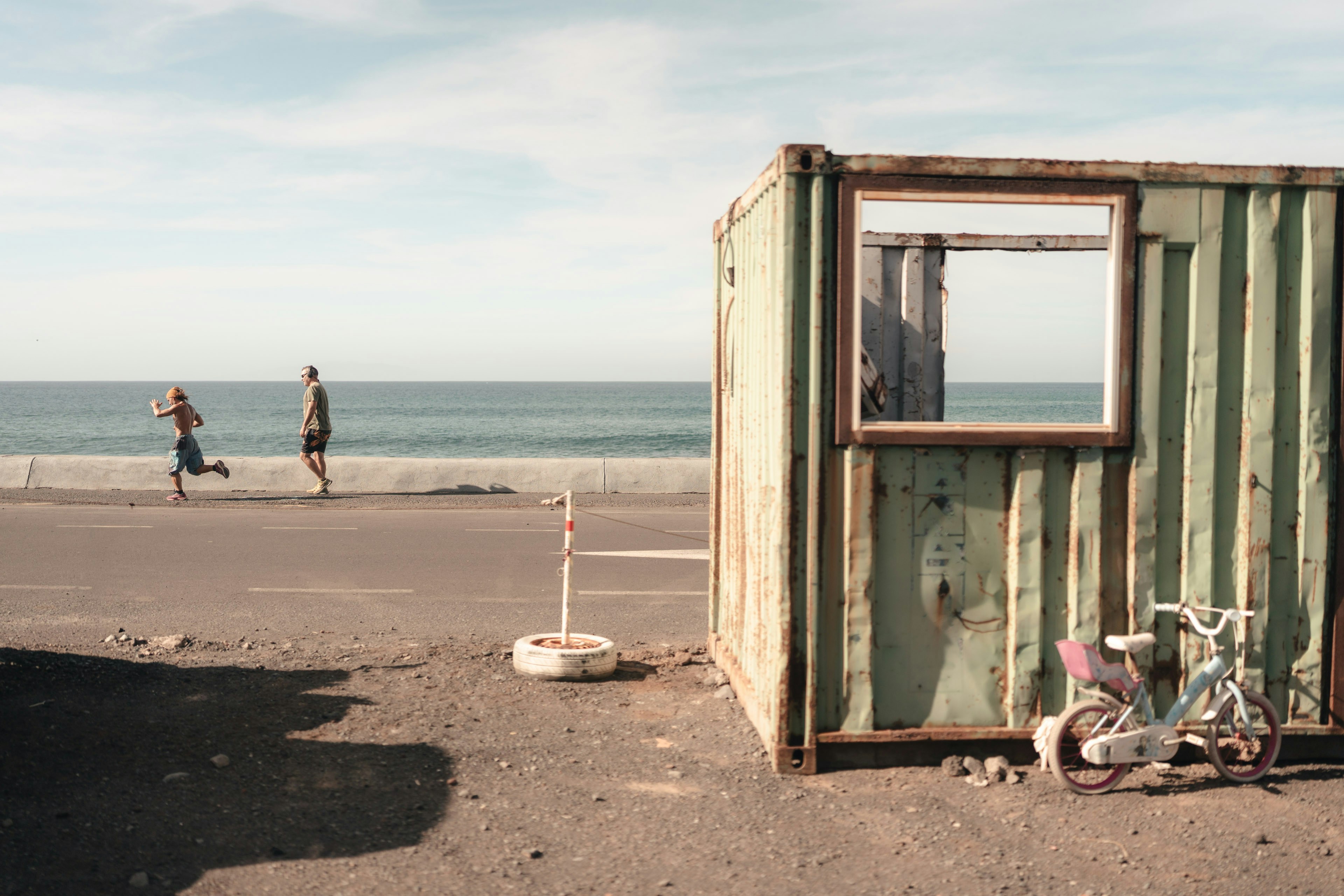 Midday Run by the Sea: A Rusted Outpost and Pedaling Toy