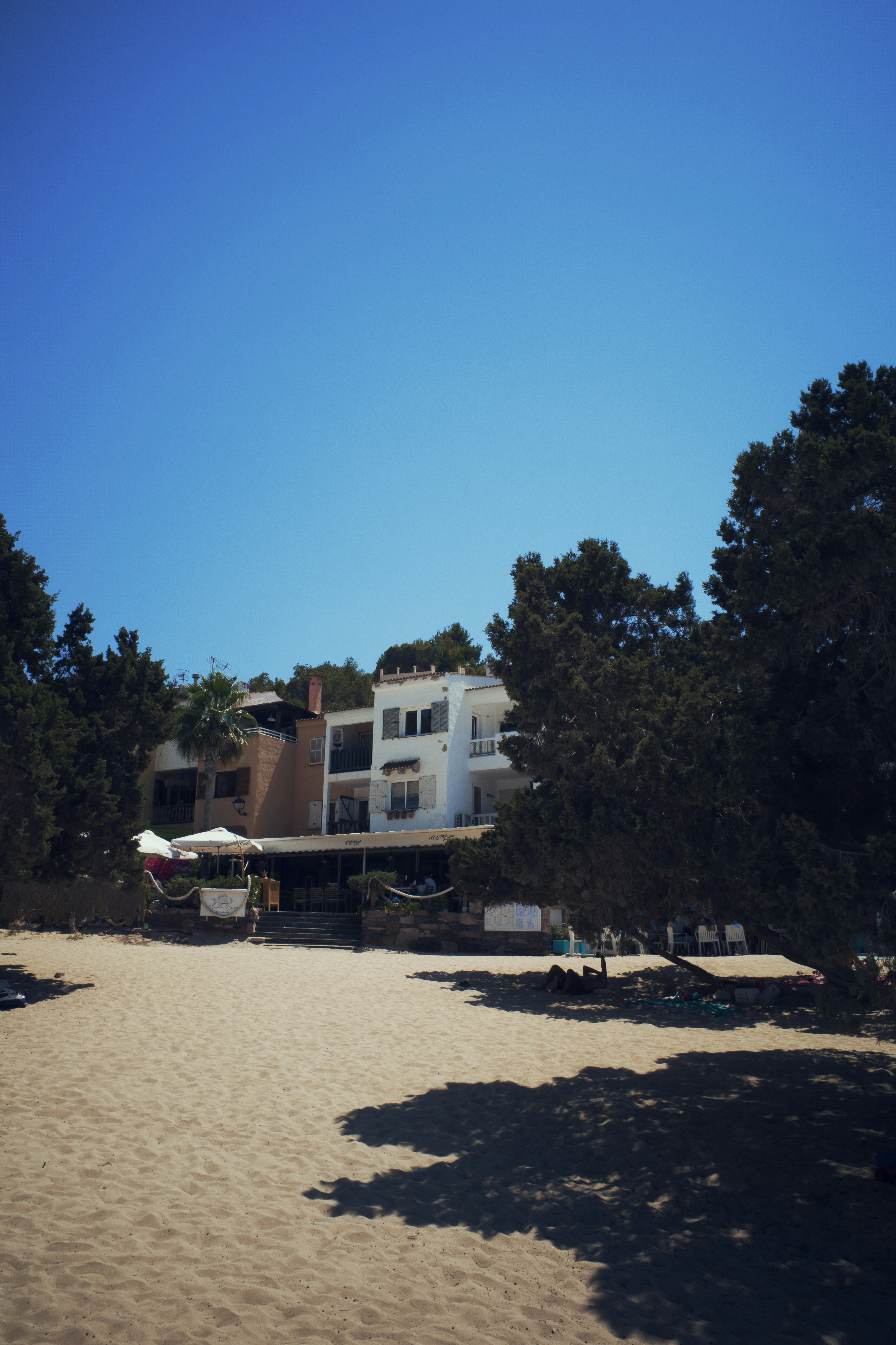 Beachfront house under a clear blue sky