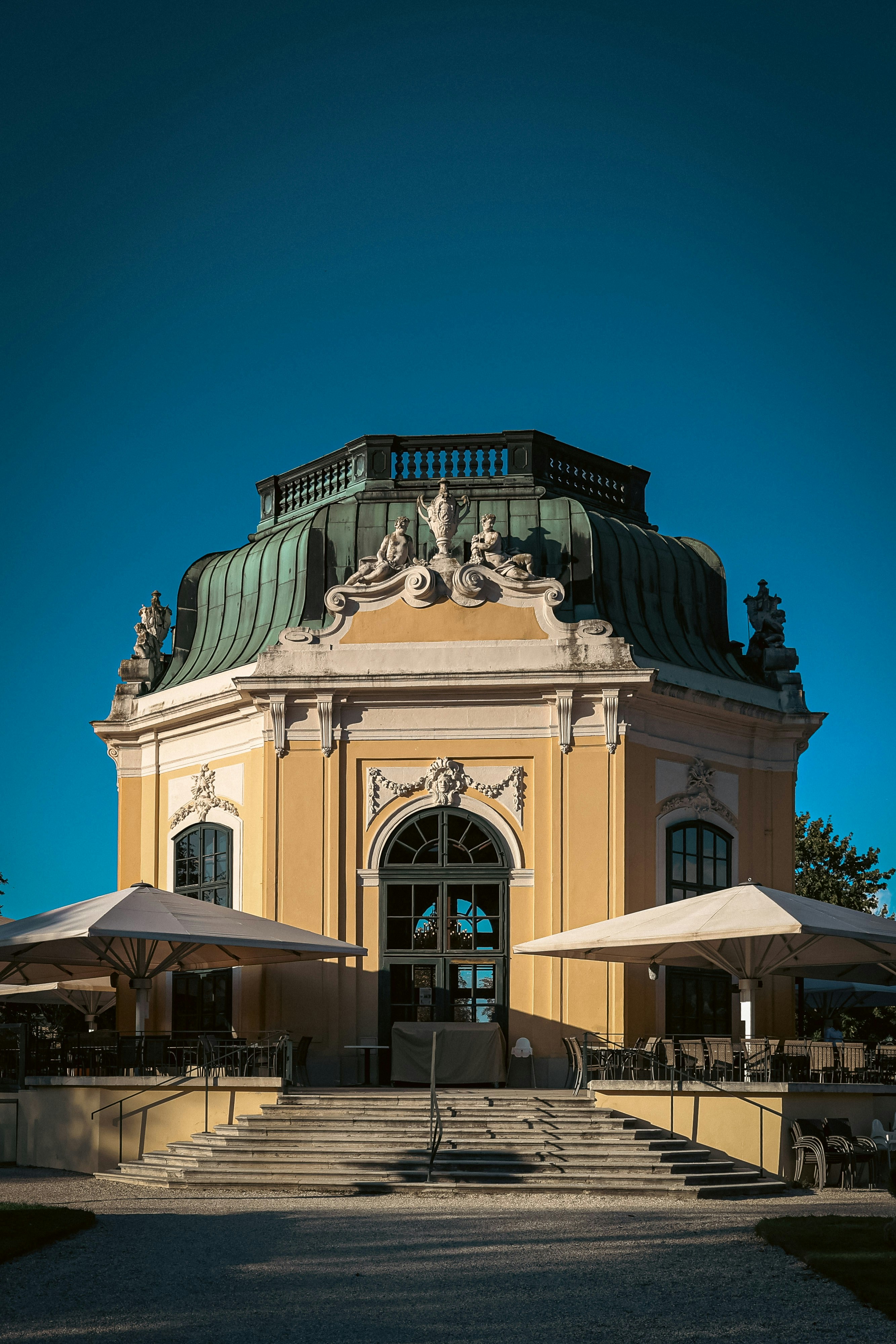 Sunlit Baroque Facade: A Yellow Chalet Adorned with Sculpted Details