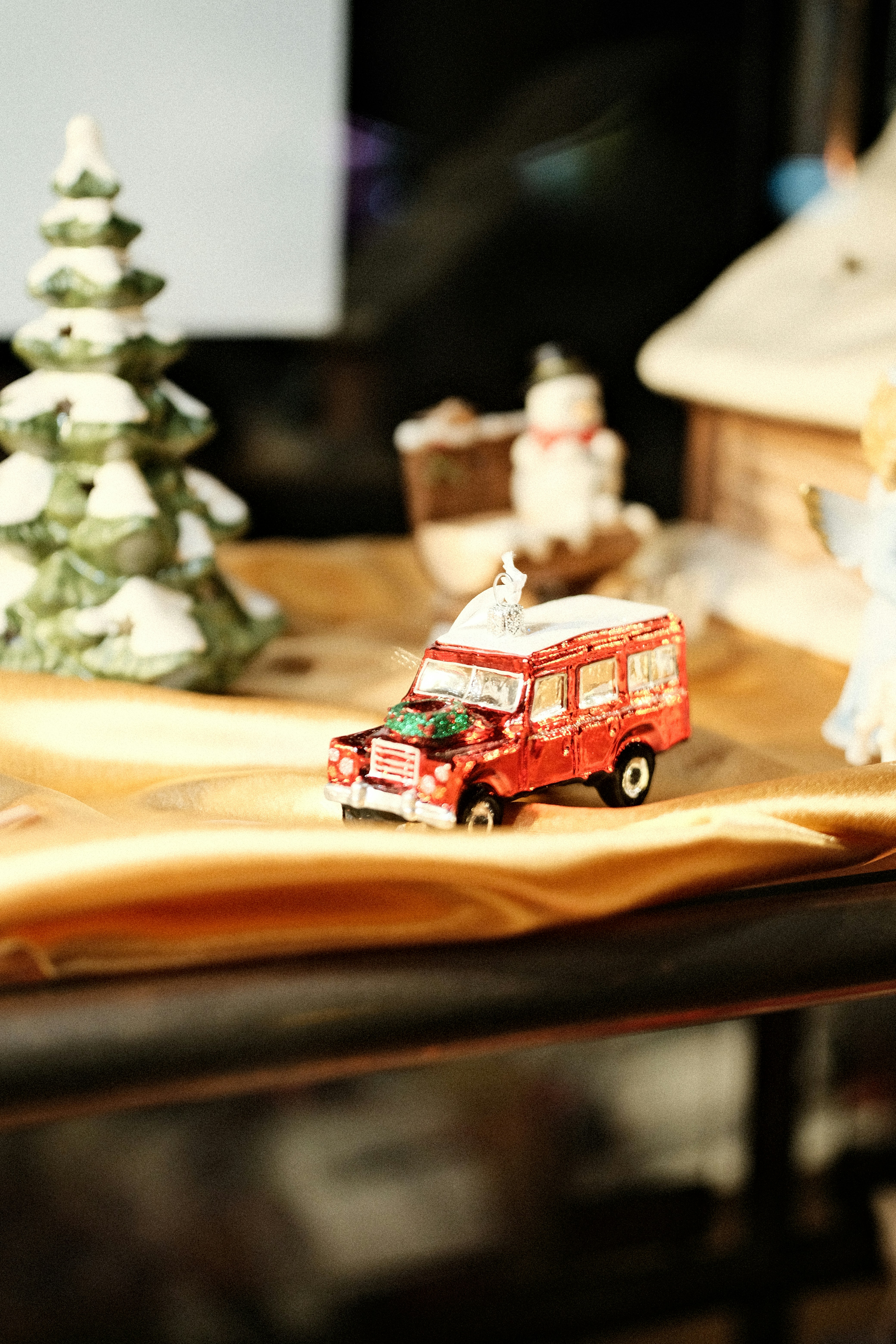 Red toy Land Rover on a display table with decorations
