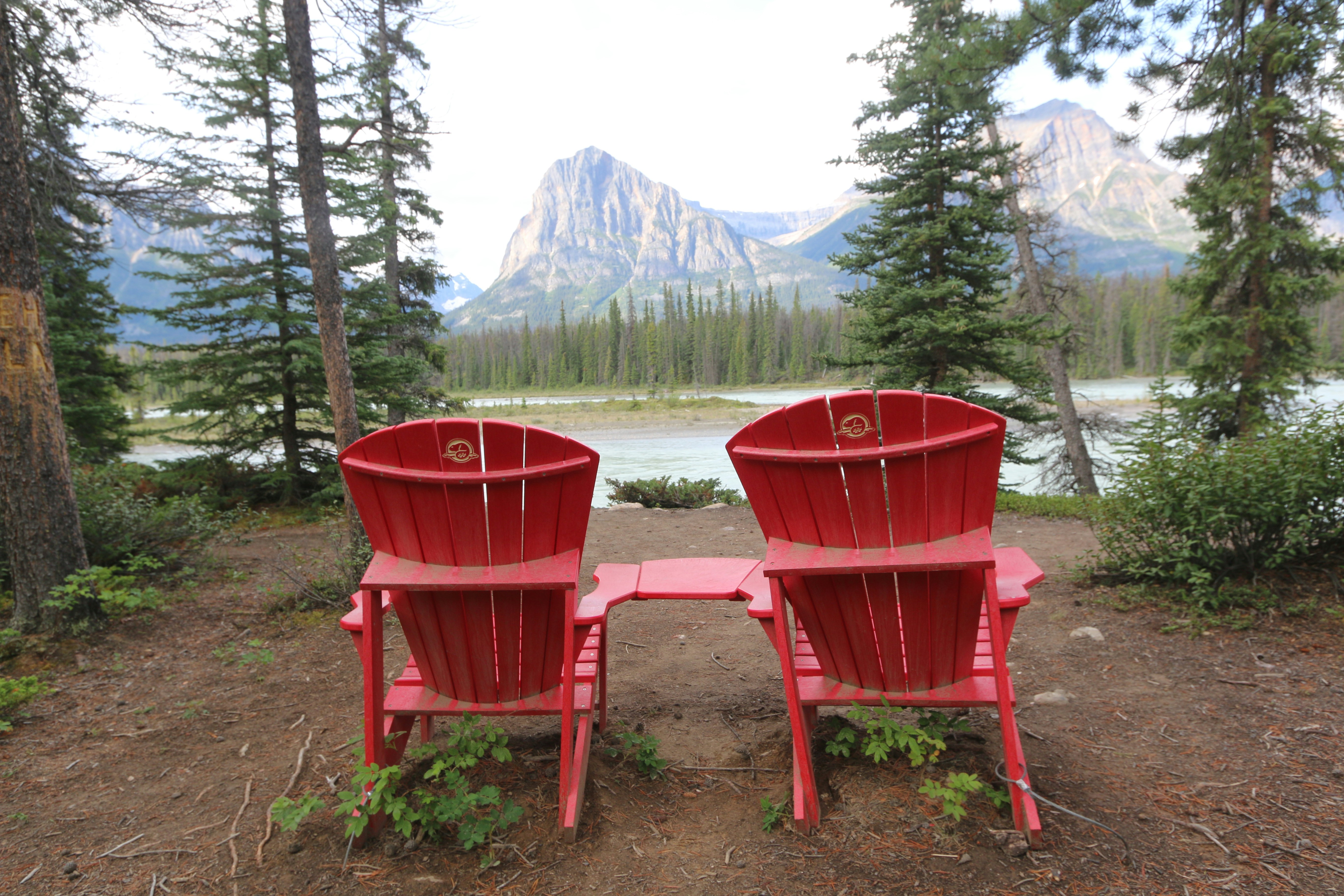 Red Adirondack Rendezvous: Chairs with Mountain Backdrop