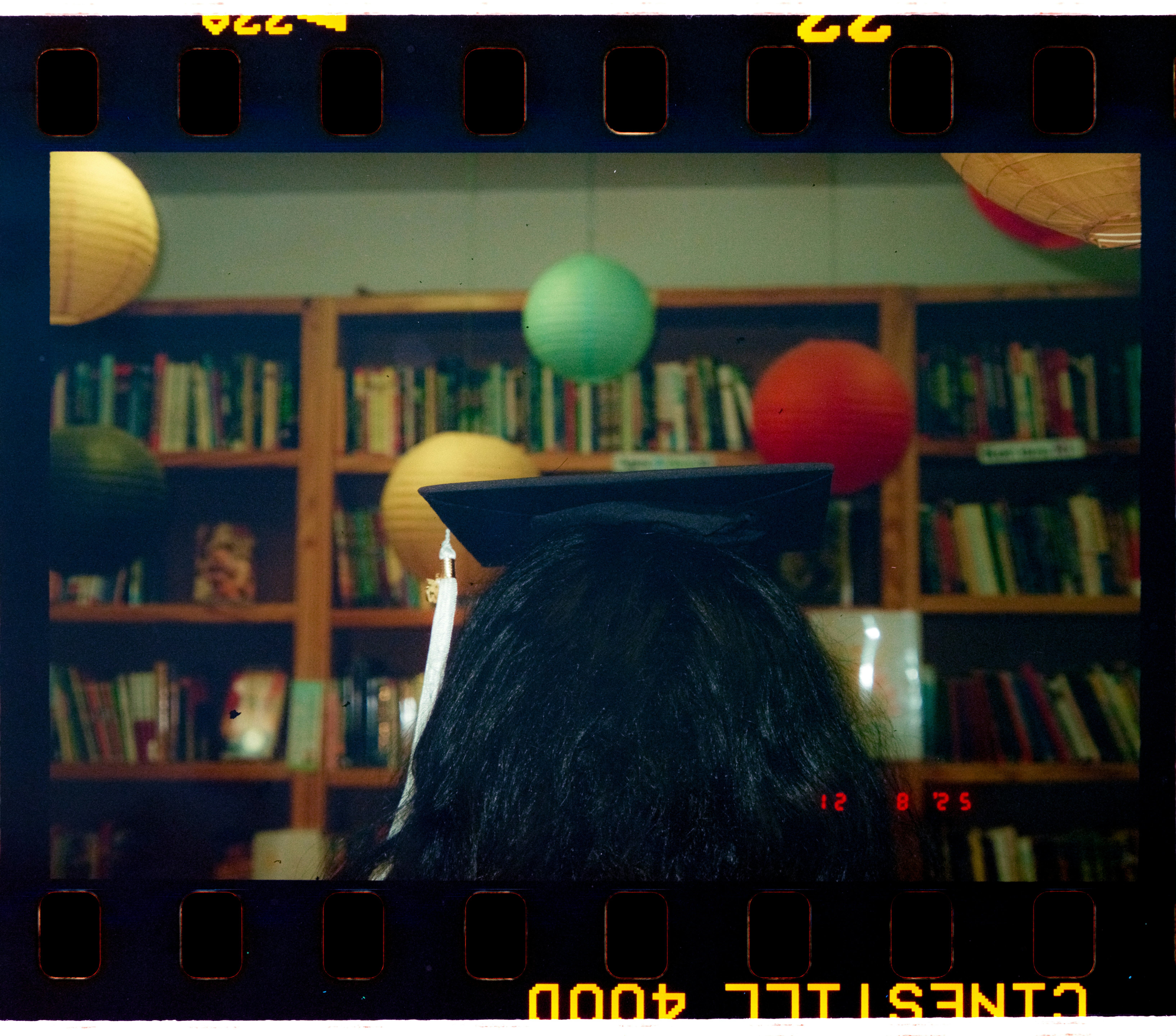 Graduation Gaze: Silhouette of a Student Before a Library Backdrop