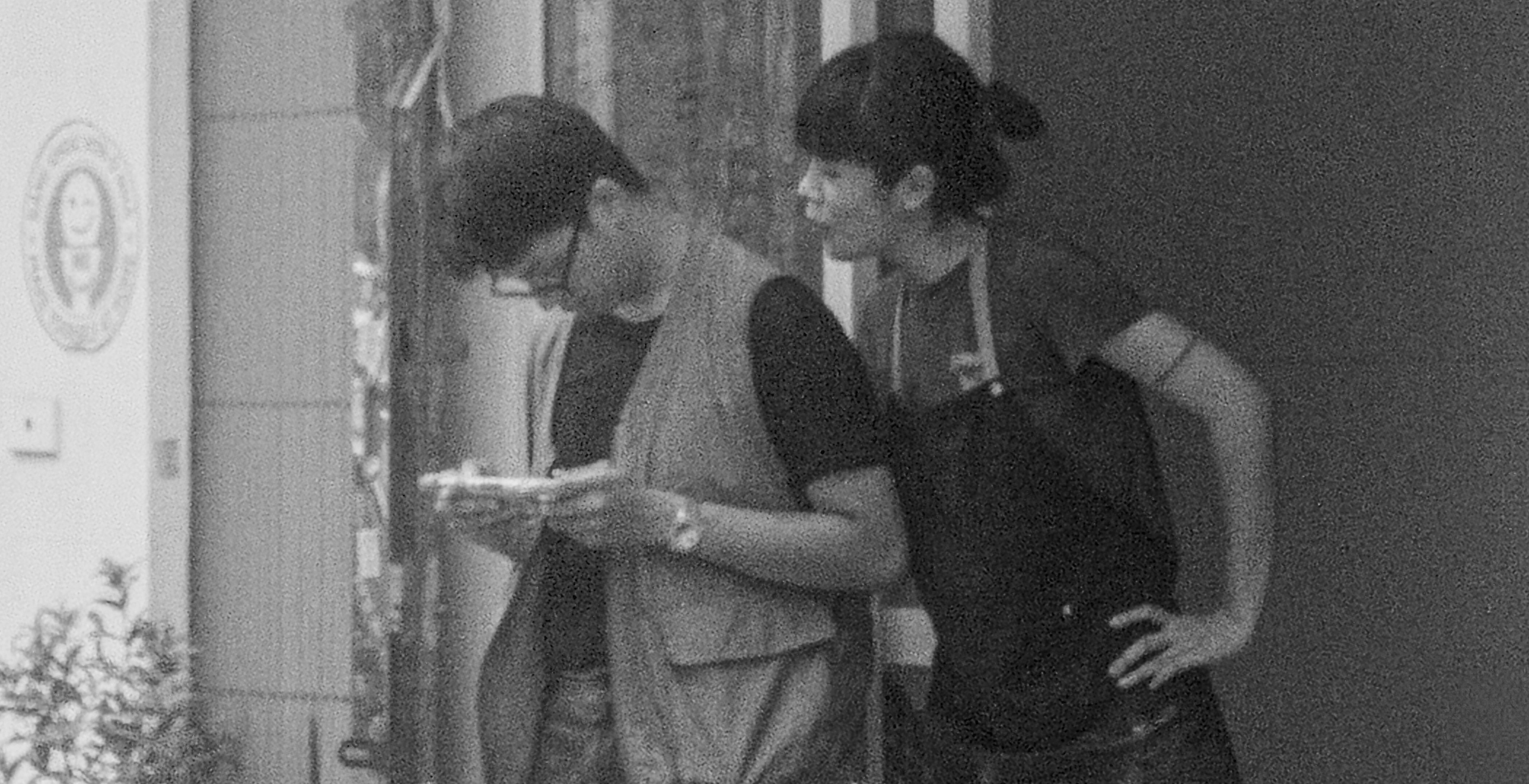 Two people looking at something small