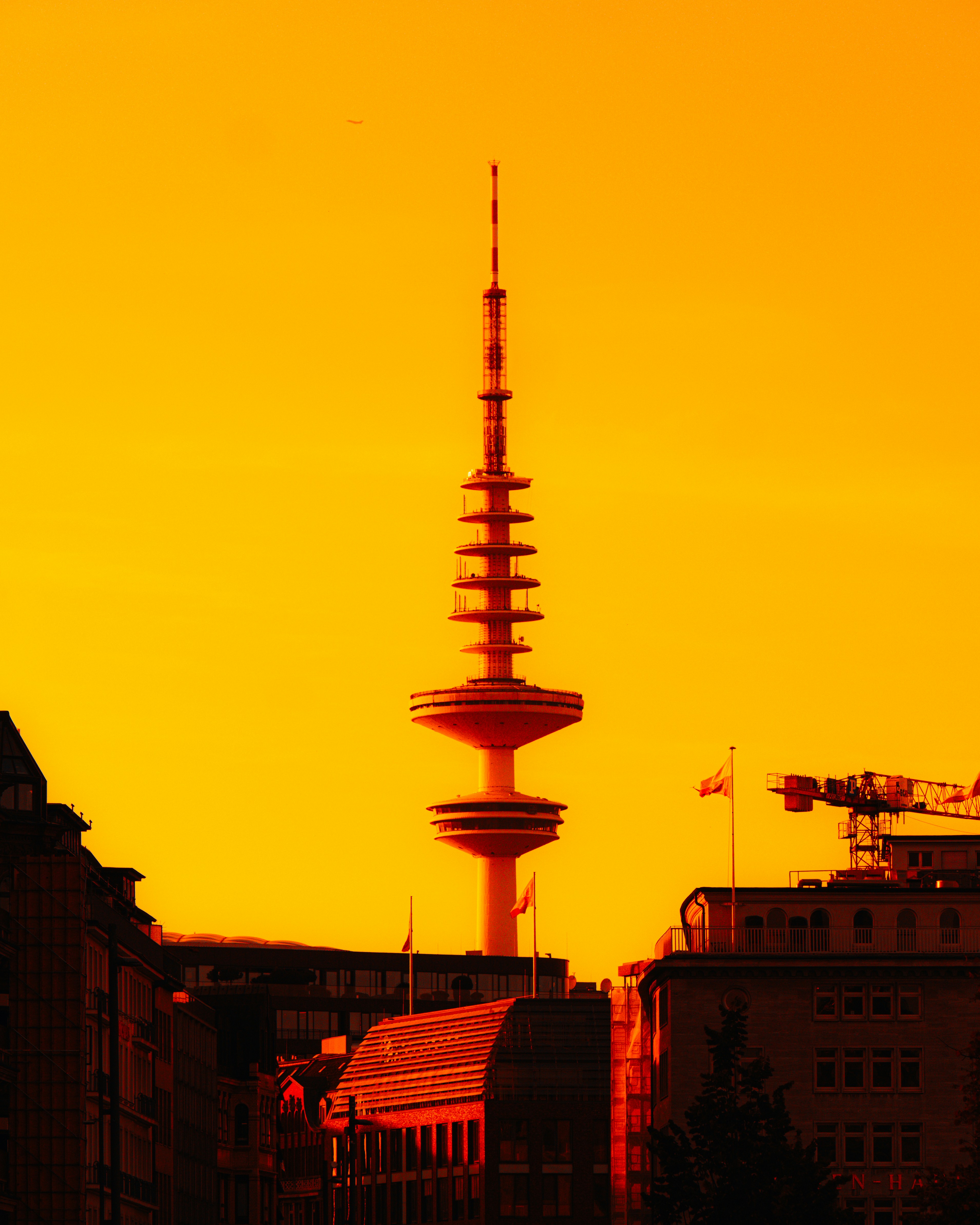 City Skyline Verse: The towering broadcast mast beneath a molten sunset
