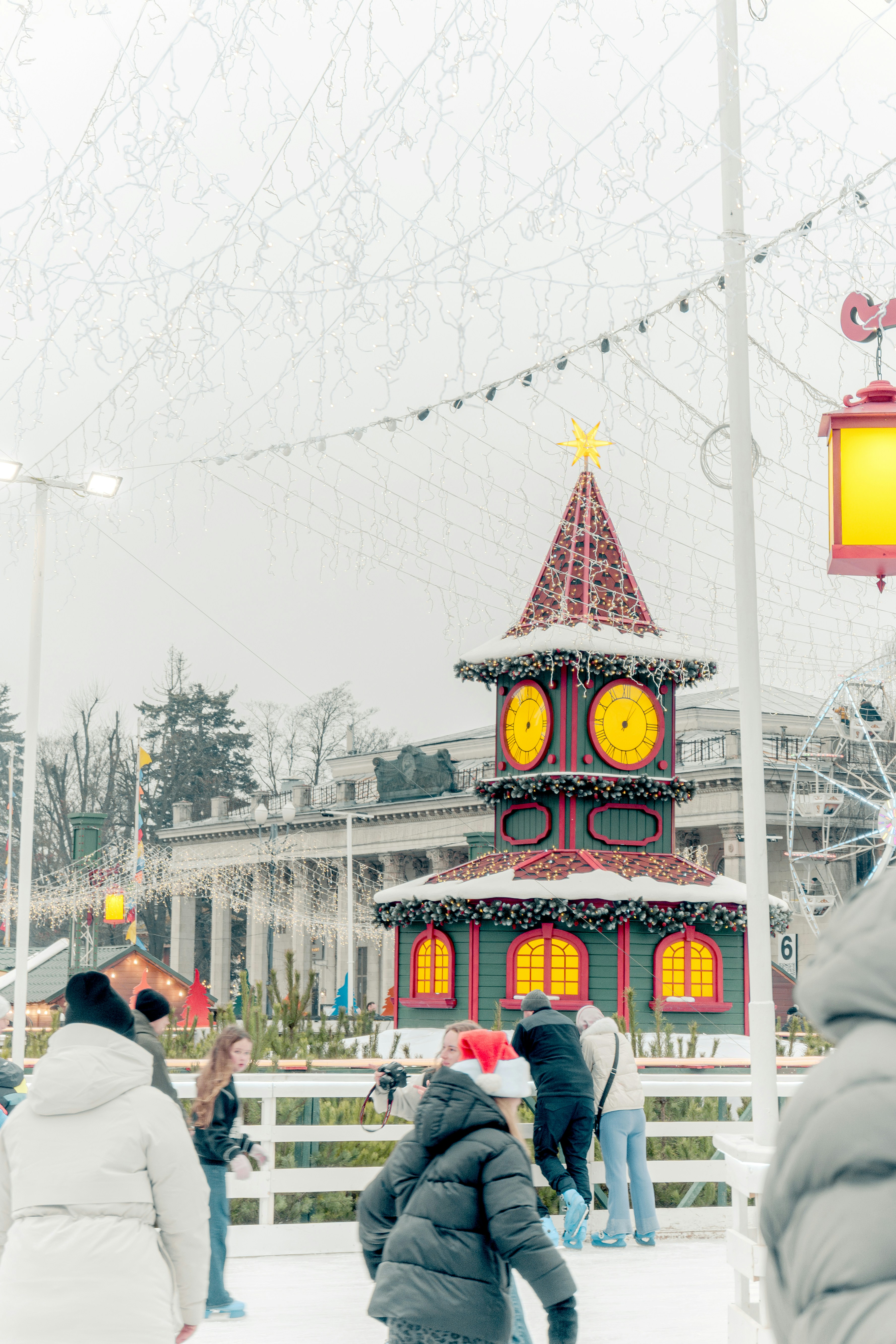 Whimsical Clock Tower Illuminated under Festive Garden Lights