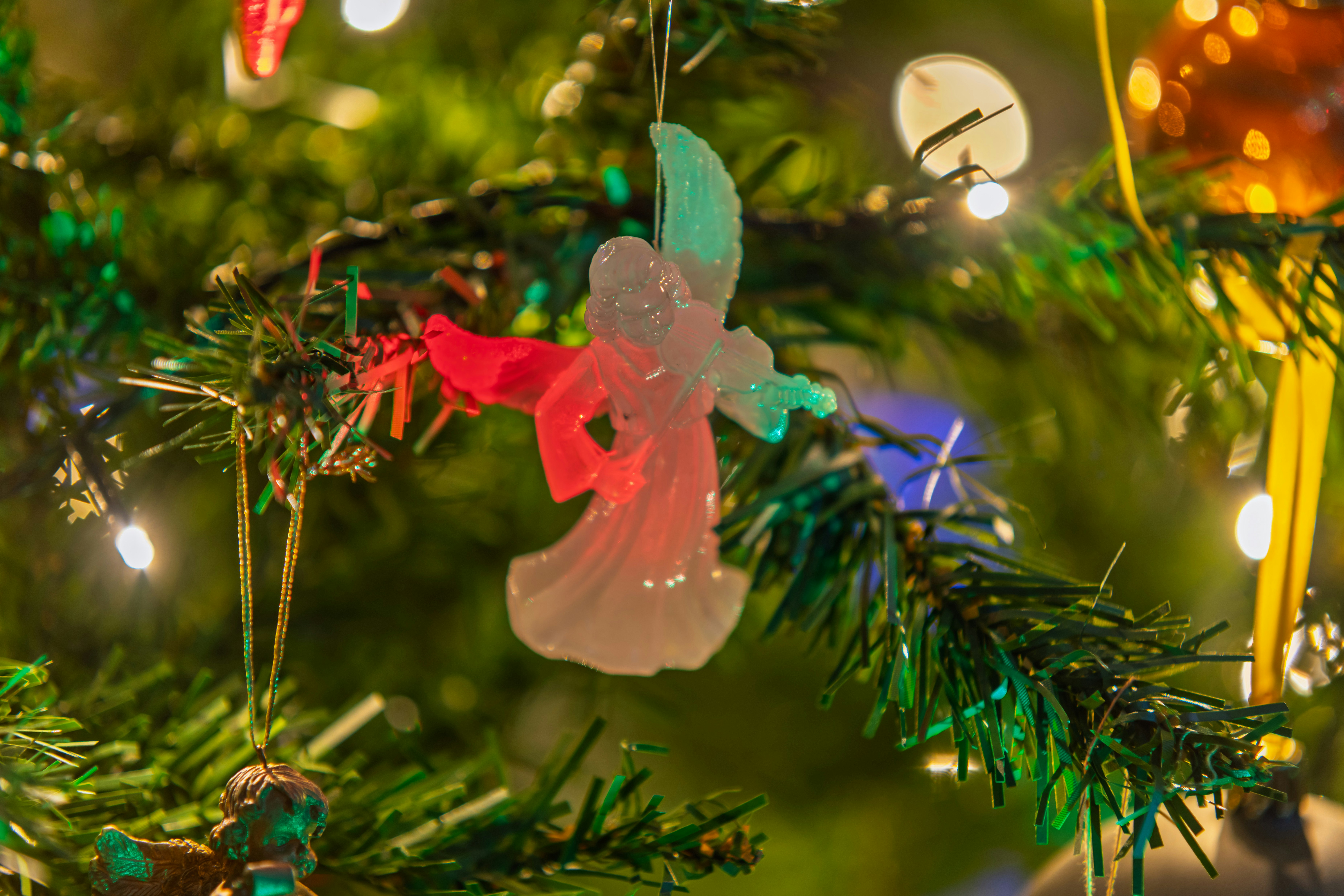 Whimsical Angel Ornament Amidst Soft Christmas Glow