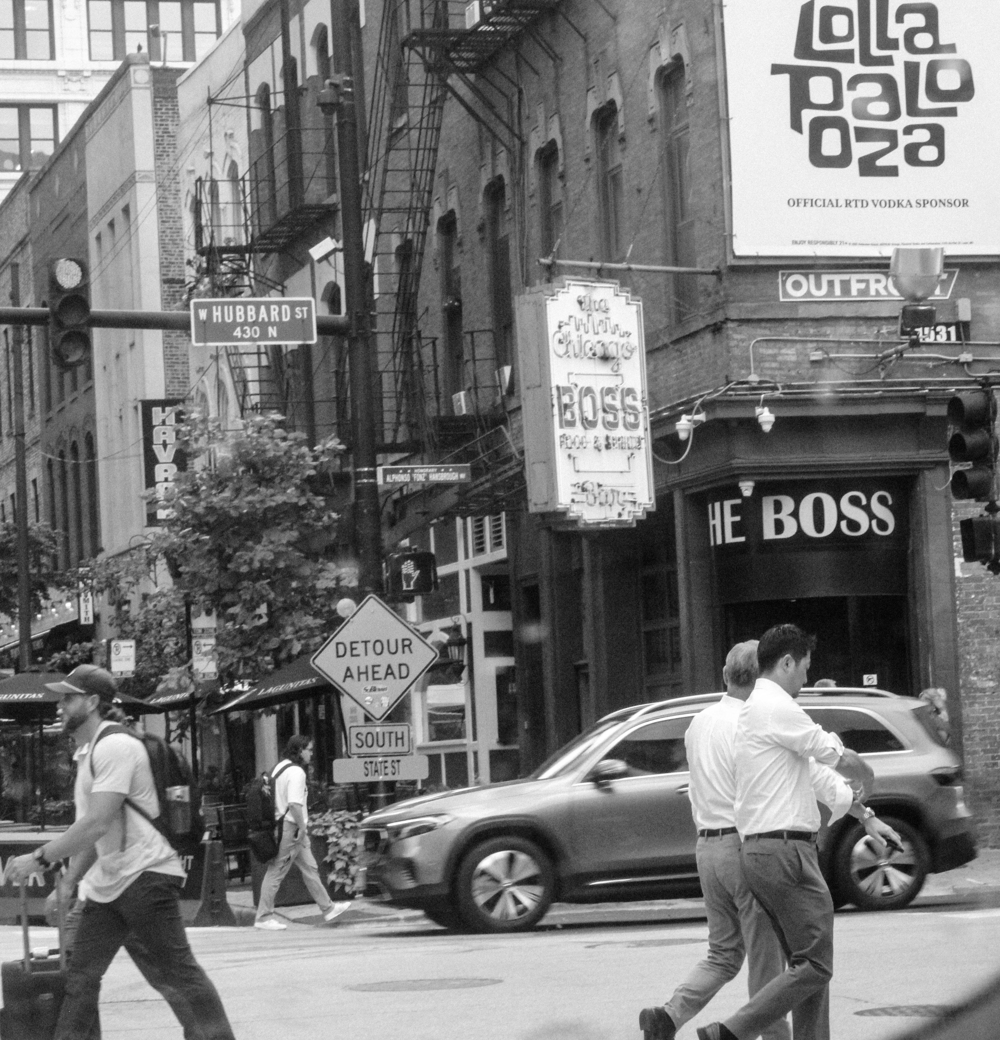 Urban Crosswalk: Street Scene with Pedestrians and a Moving Car