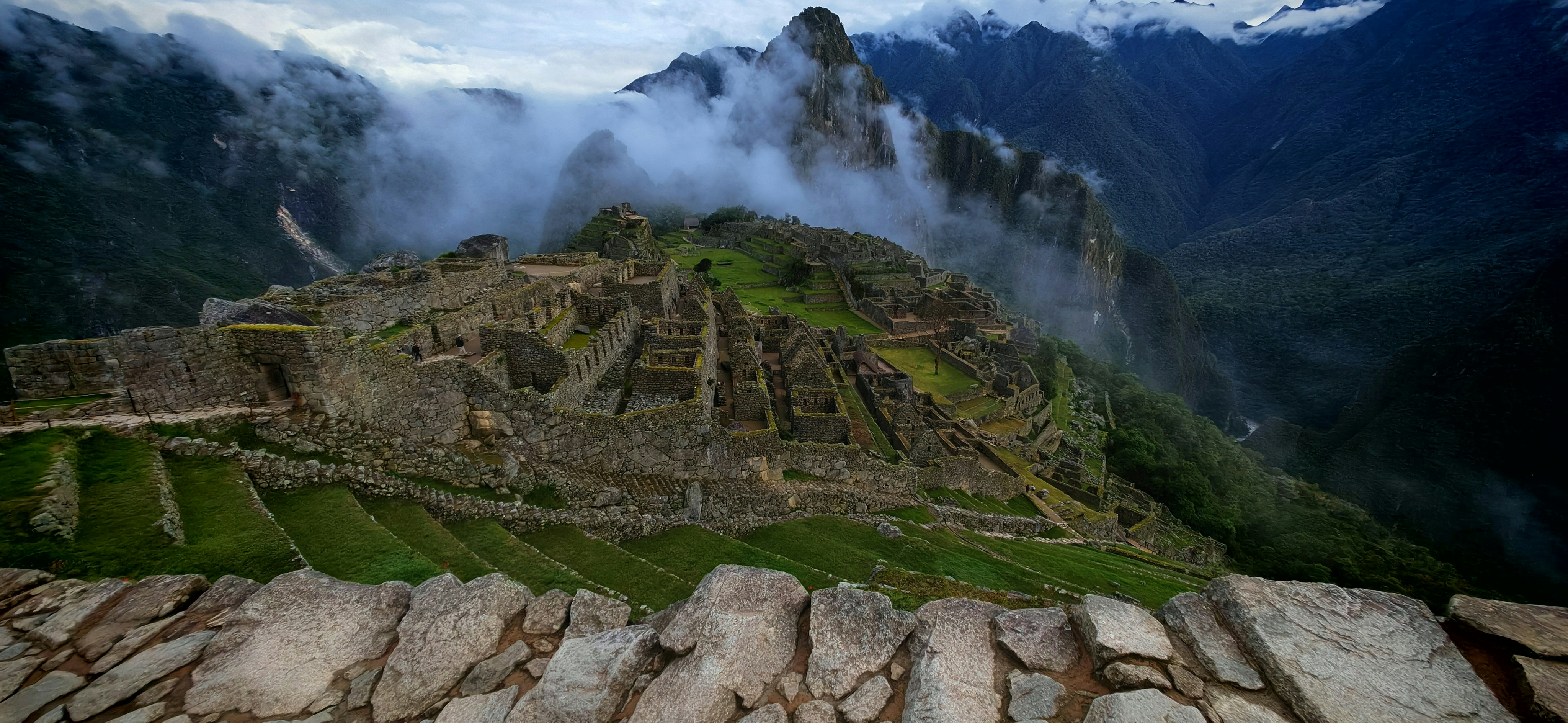 Ancient stone ruins on a misty mountain landscape