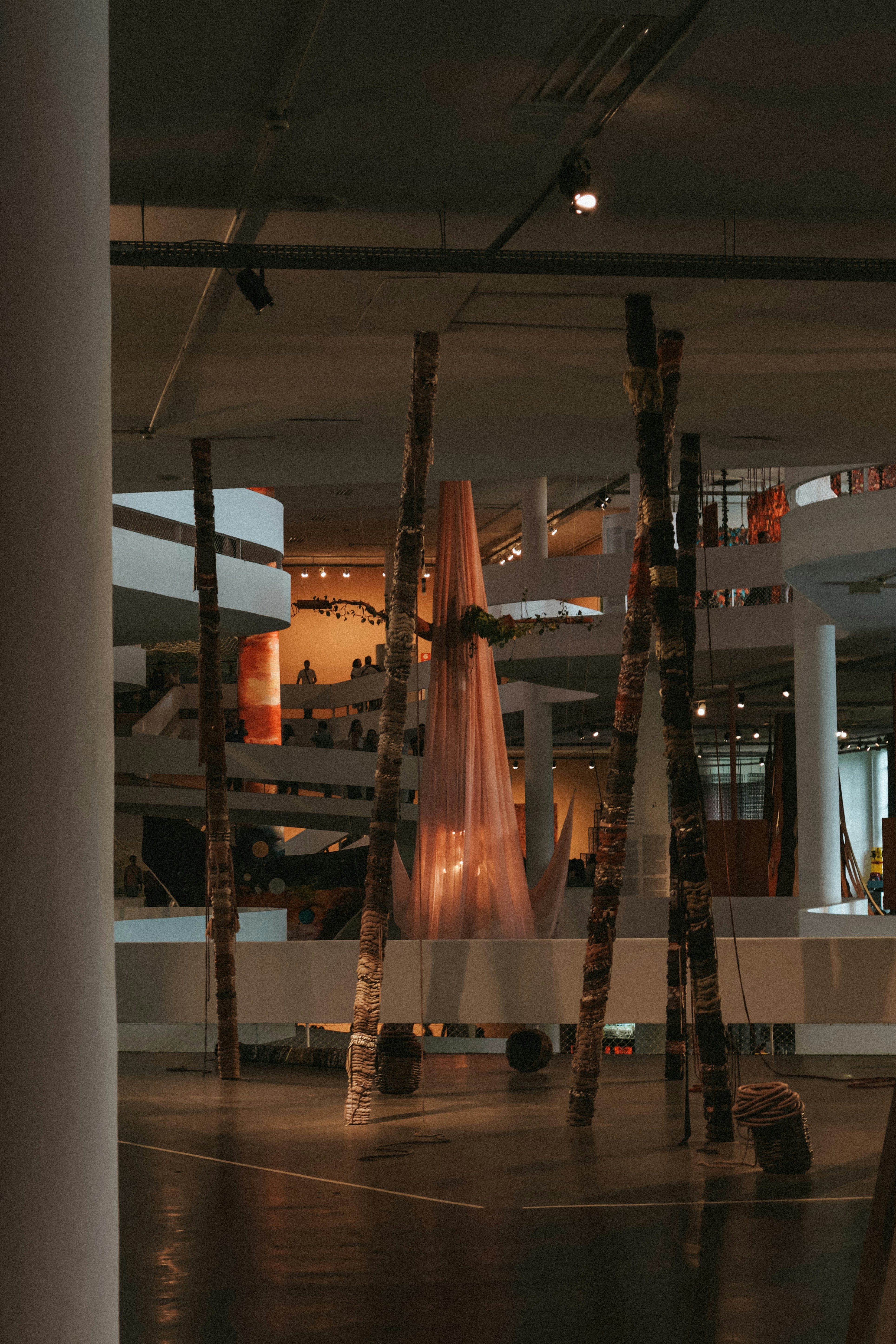 Indoor art installation with tall wooden structures and fabric ...