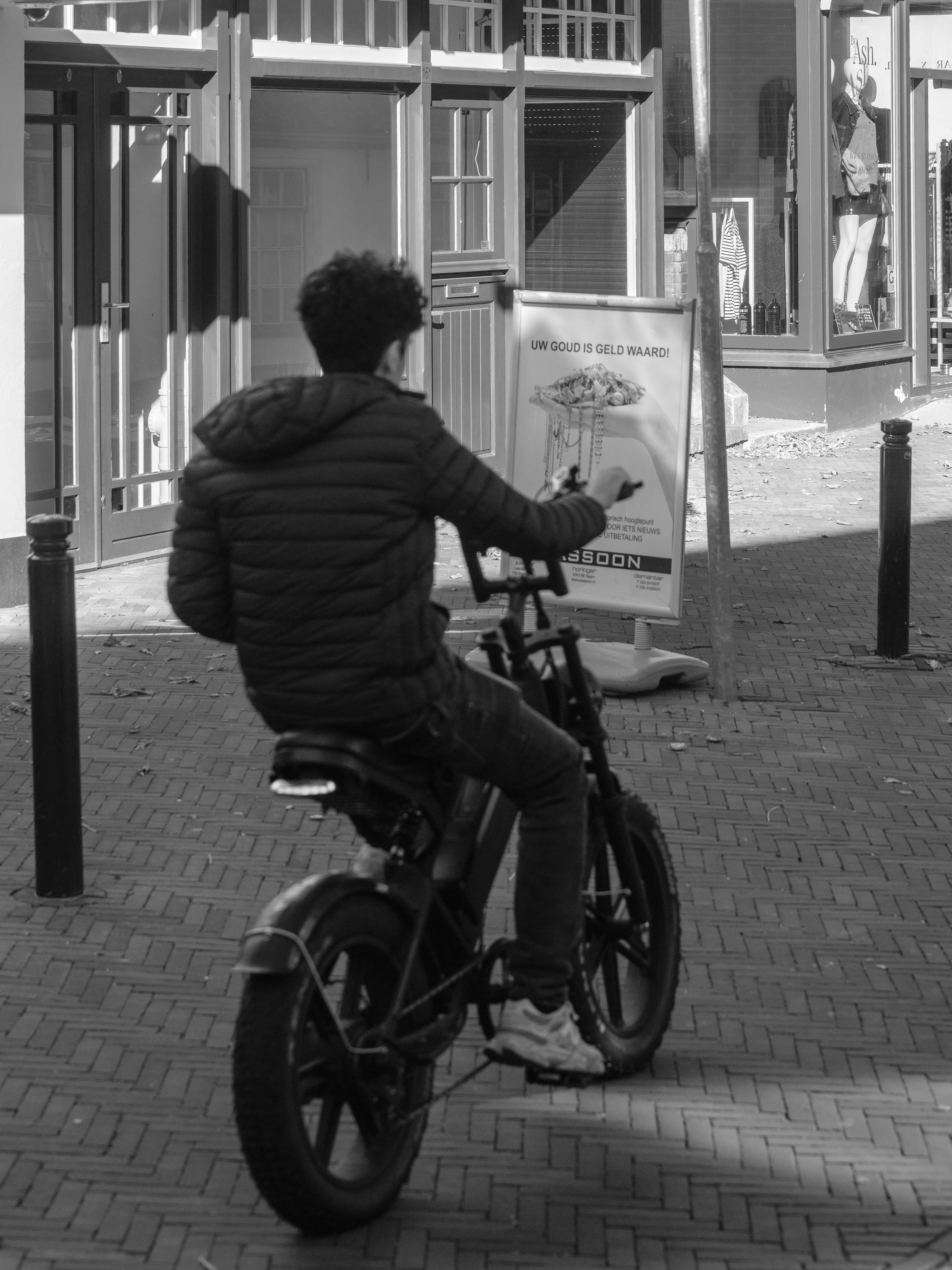 Urban Rider: A Quiet Moment on a Cobbled Street