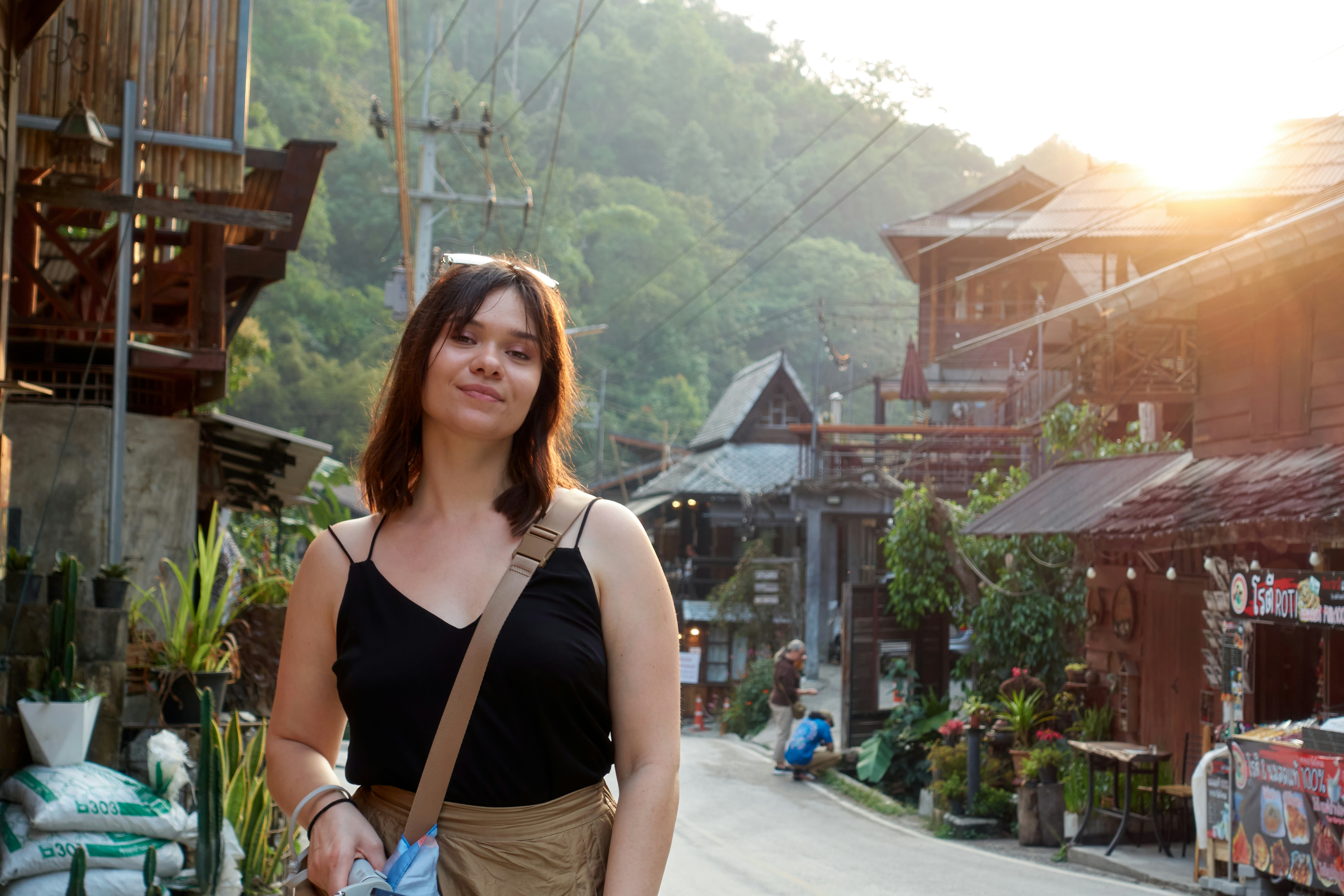 Sunlit Village Portrait: A Quiet Moment on a Mountain Road