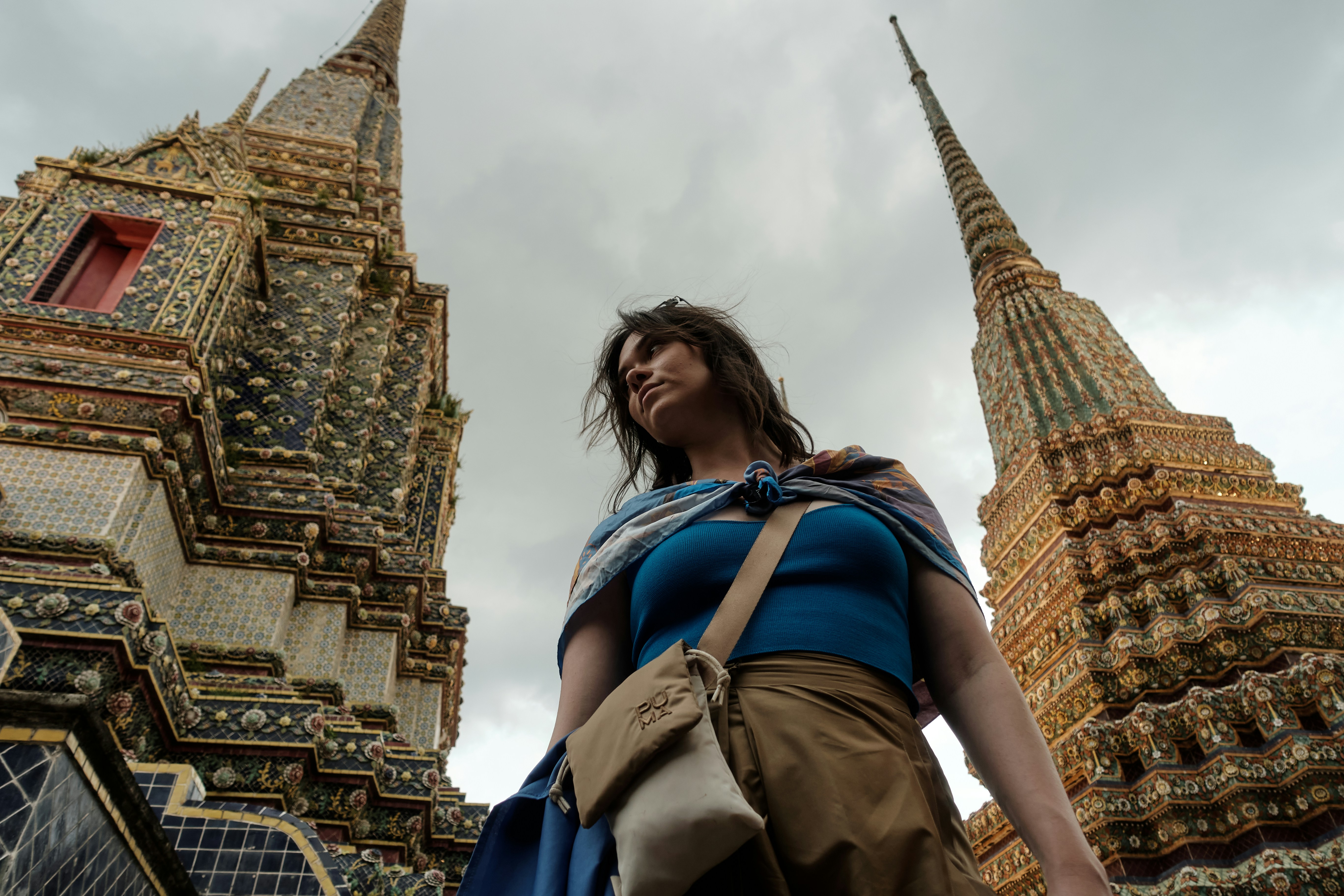 Beyond the Spires: A Traveler Stands Tall beneath Bangkok’s Golden Towers