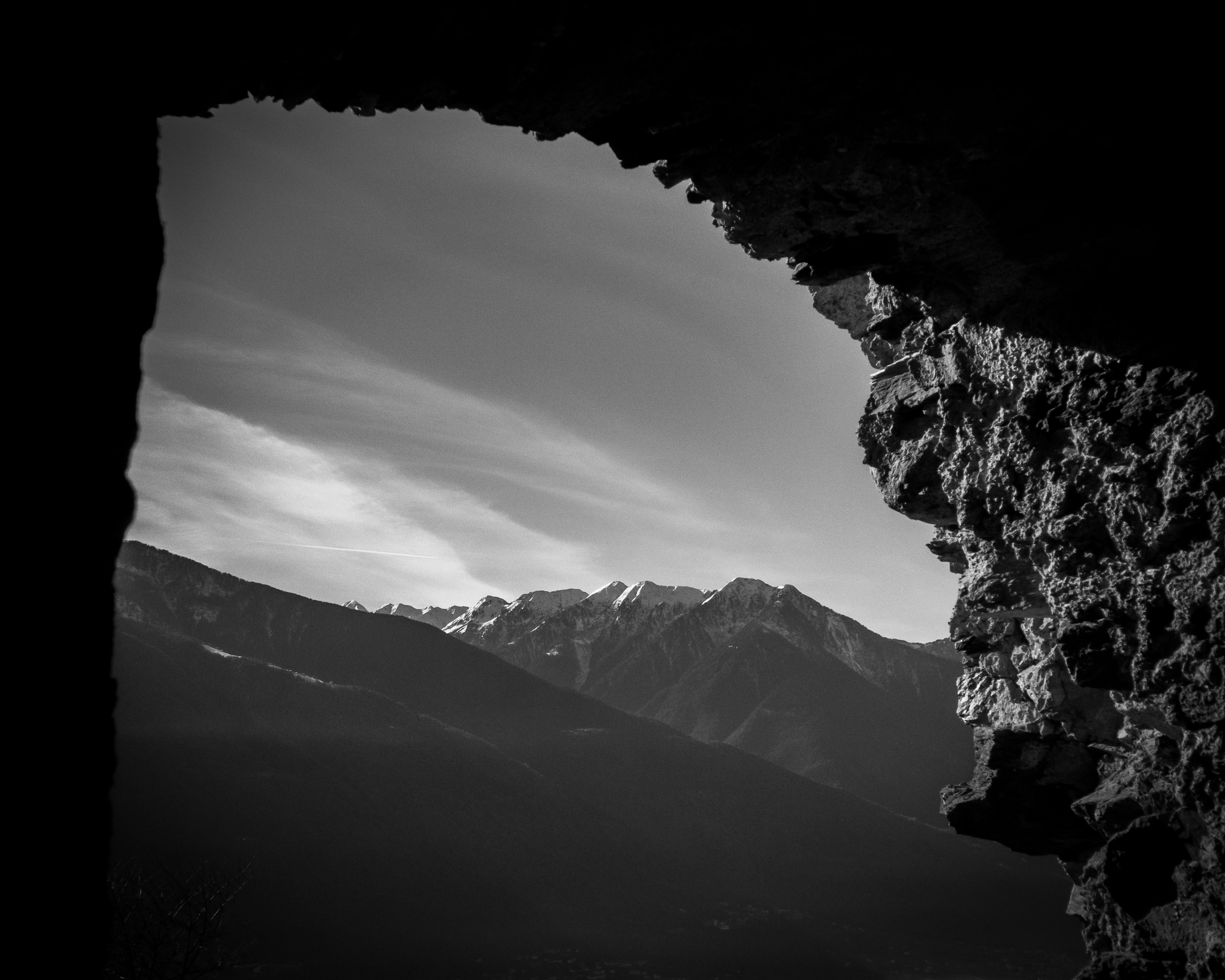 Rim of the Hidden Valley: A Mountain Corridor Framed by Cave Shadows