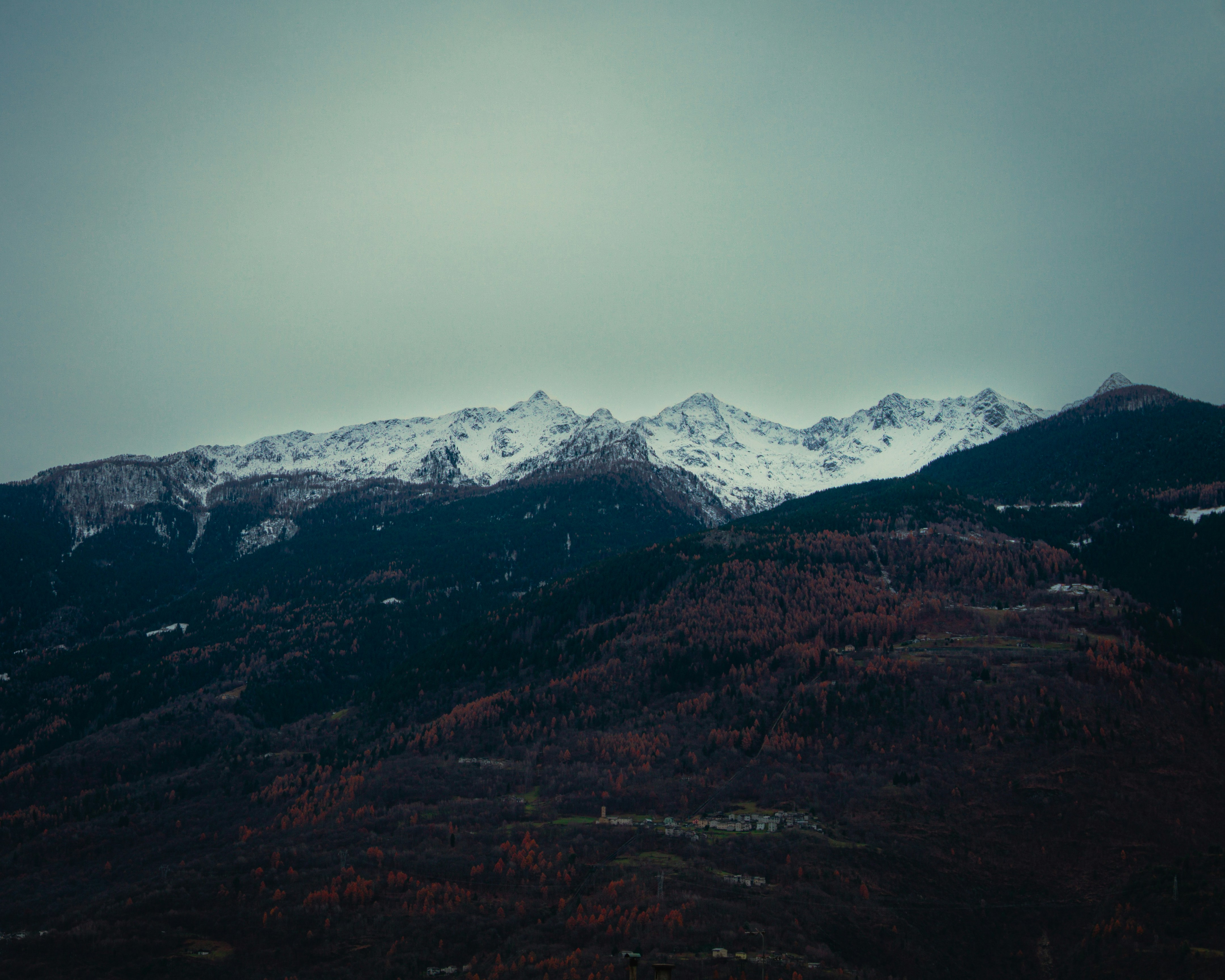 Snow-kissed Ridge Above Dark Valleys