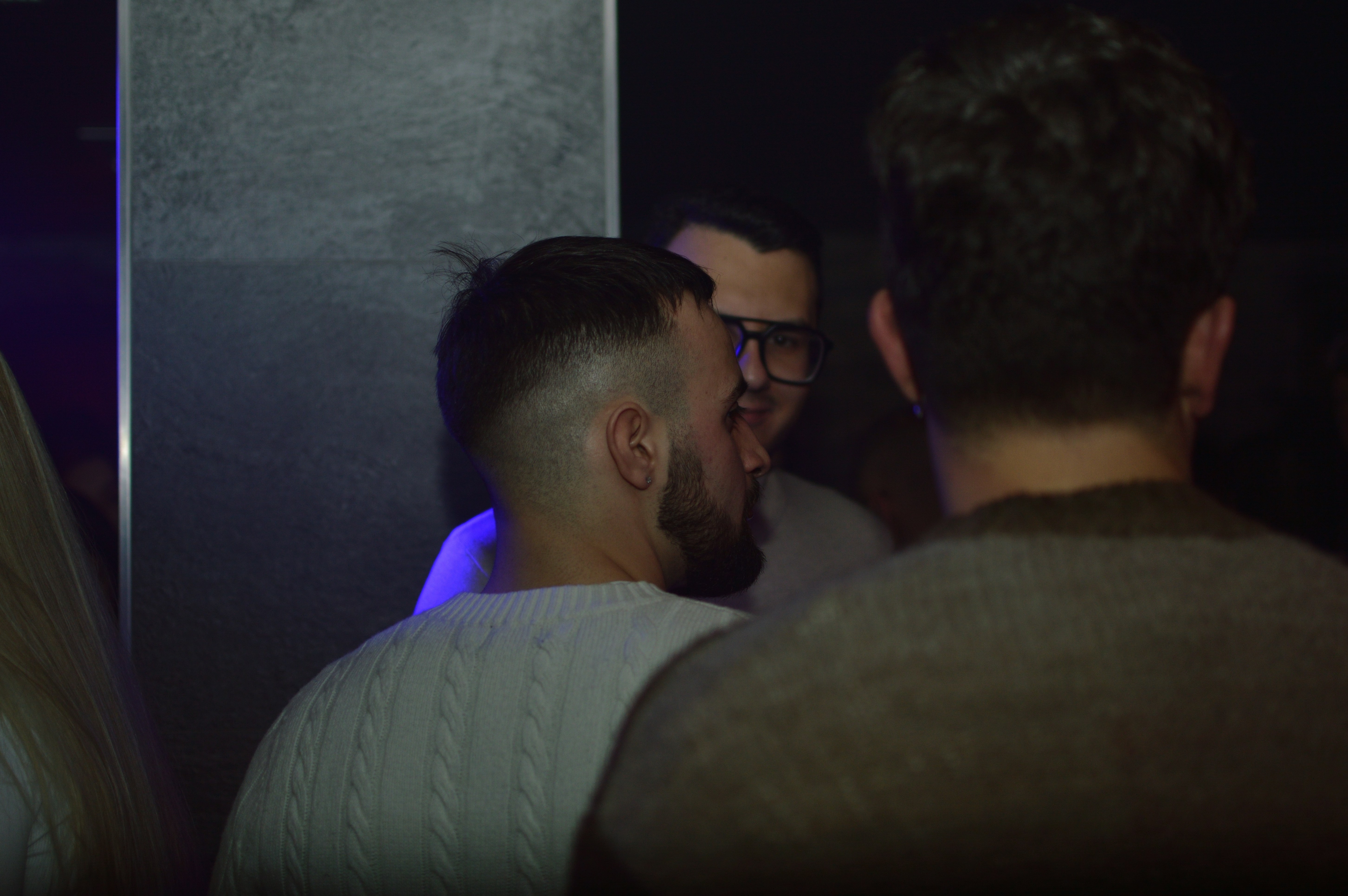 Faces in the Crowd: A Quiet Moment Amid Neon Night
