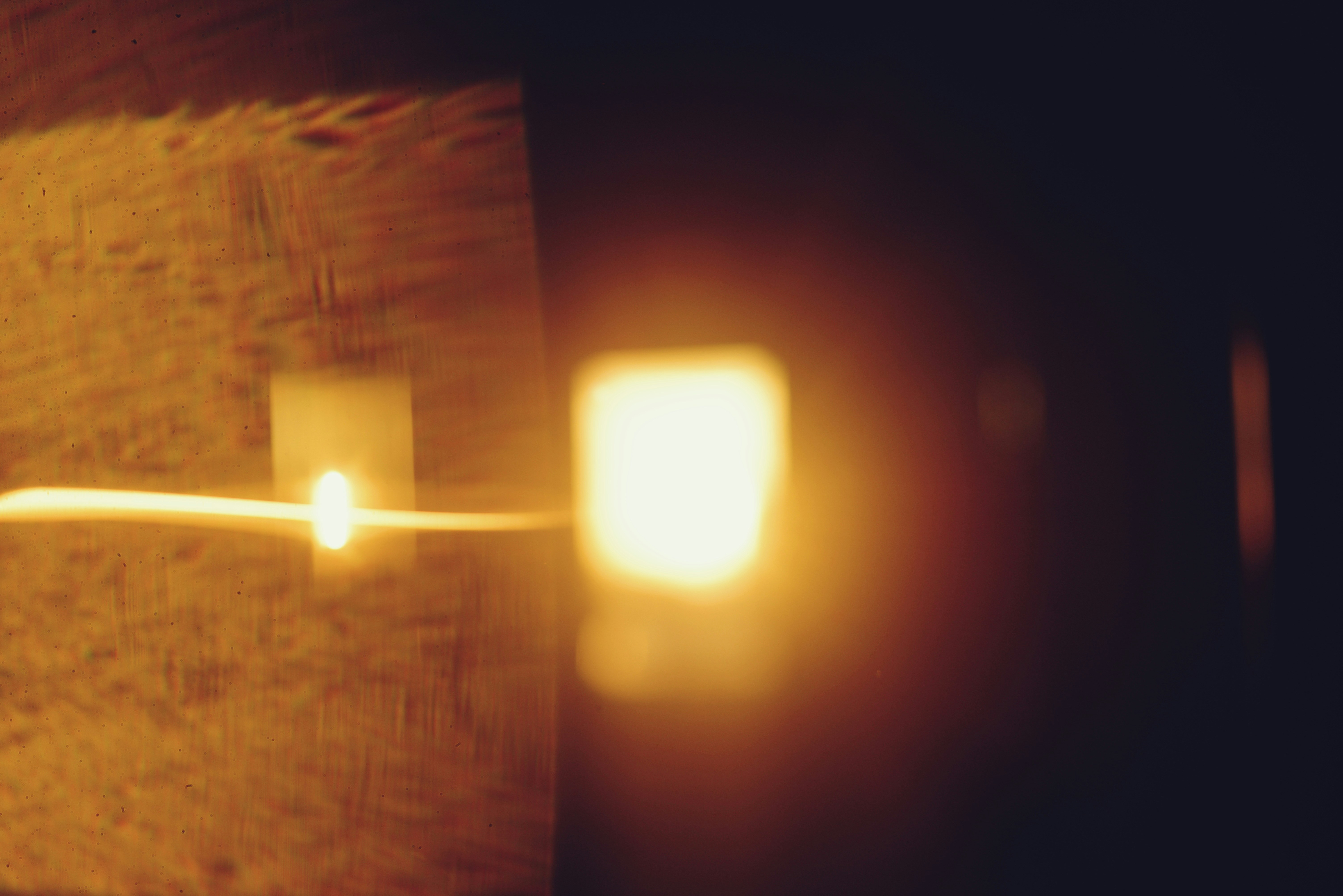 Warm glow through a slit of light in a textured panel