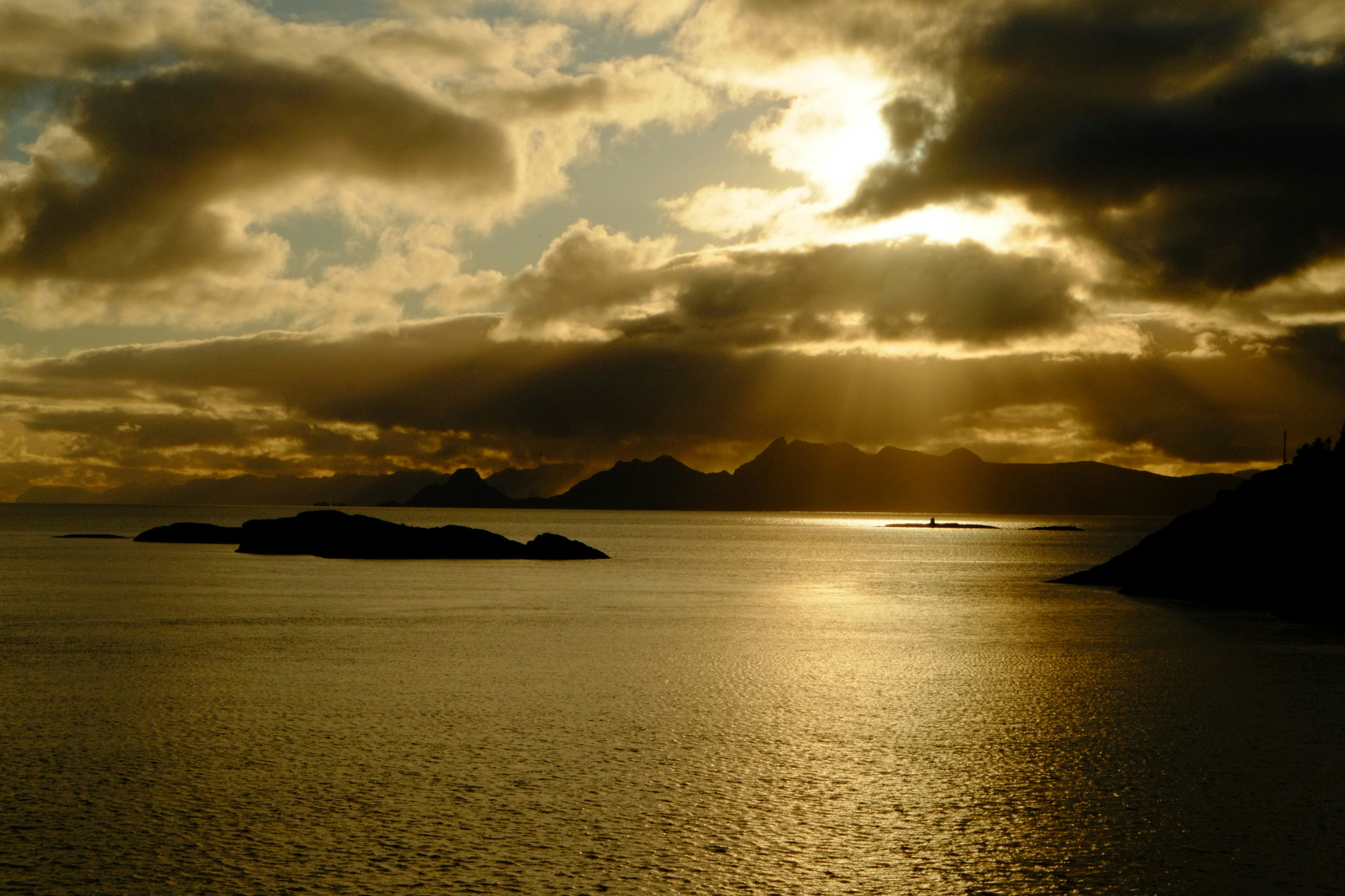 Sunlit Damnation: silhouette islands under a molten sky