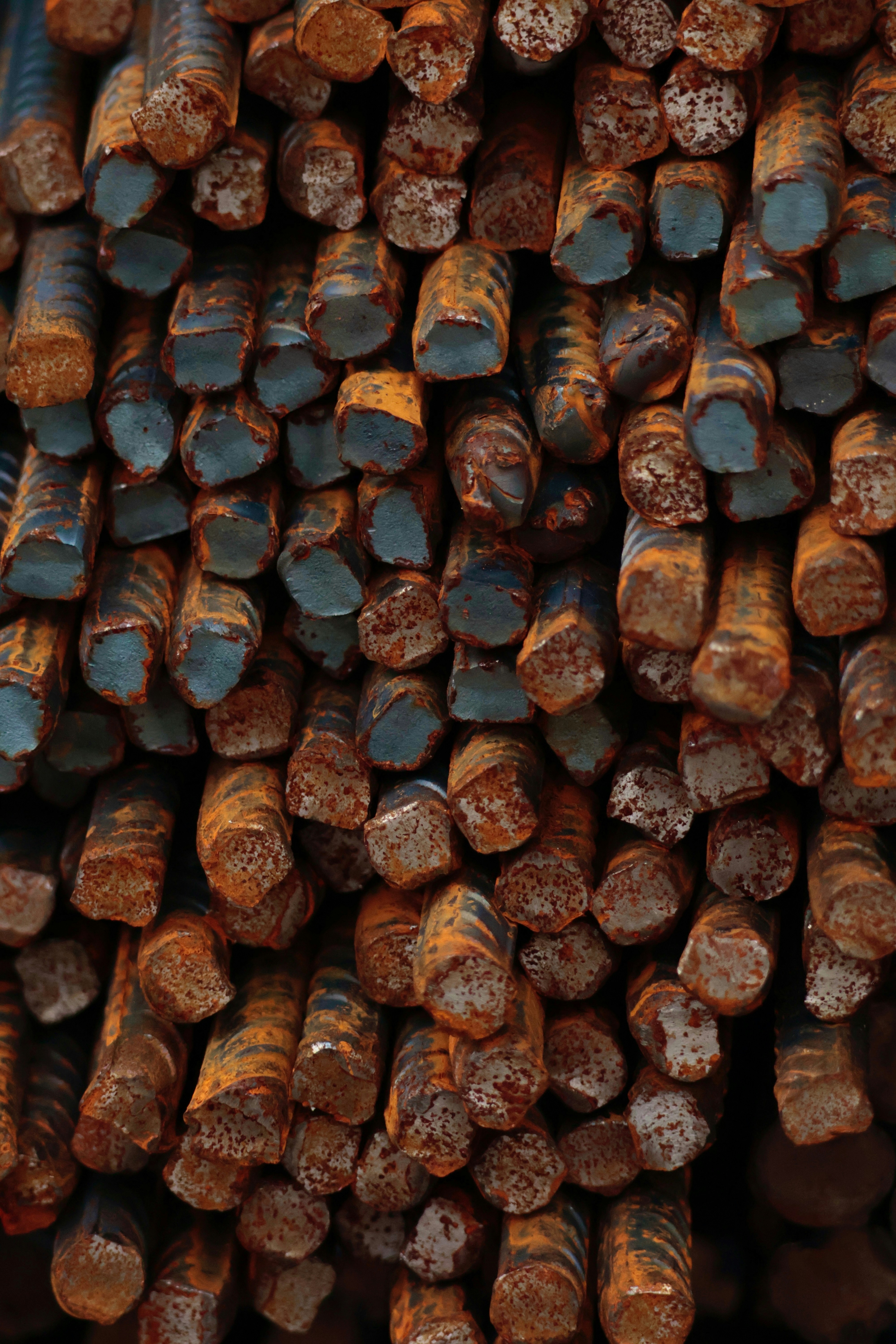 Iron River: A Portrait of Weathered Rods Stacked in Rust and Dust