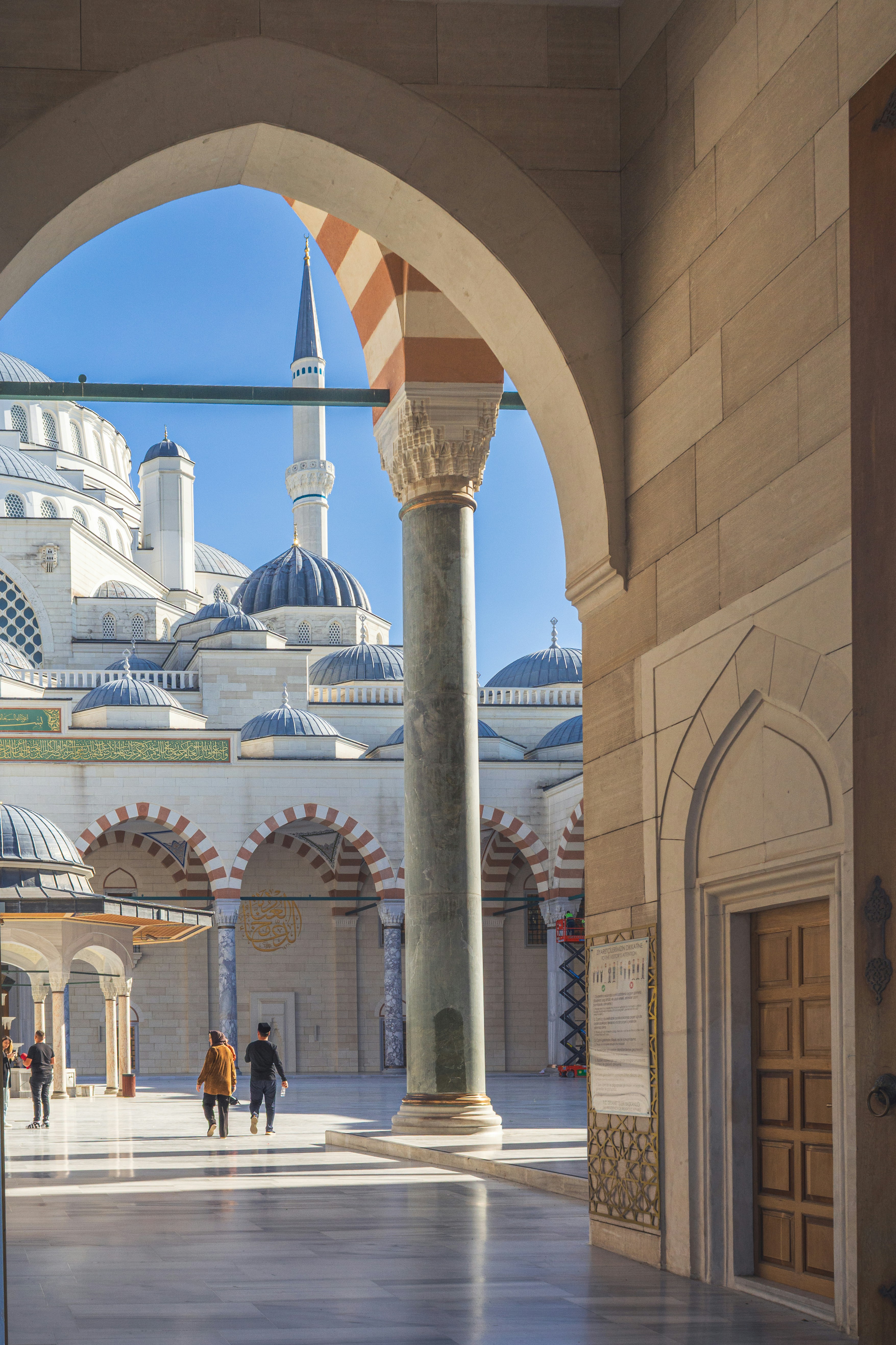 Courtyard of Arches: A Mosque Courtyard Framed by Marble and Minarets