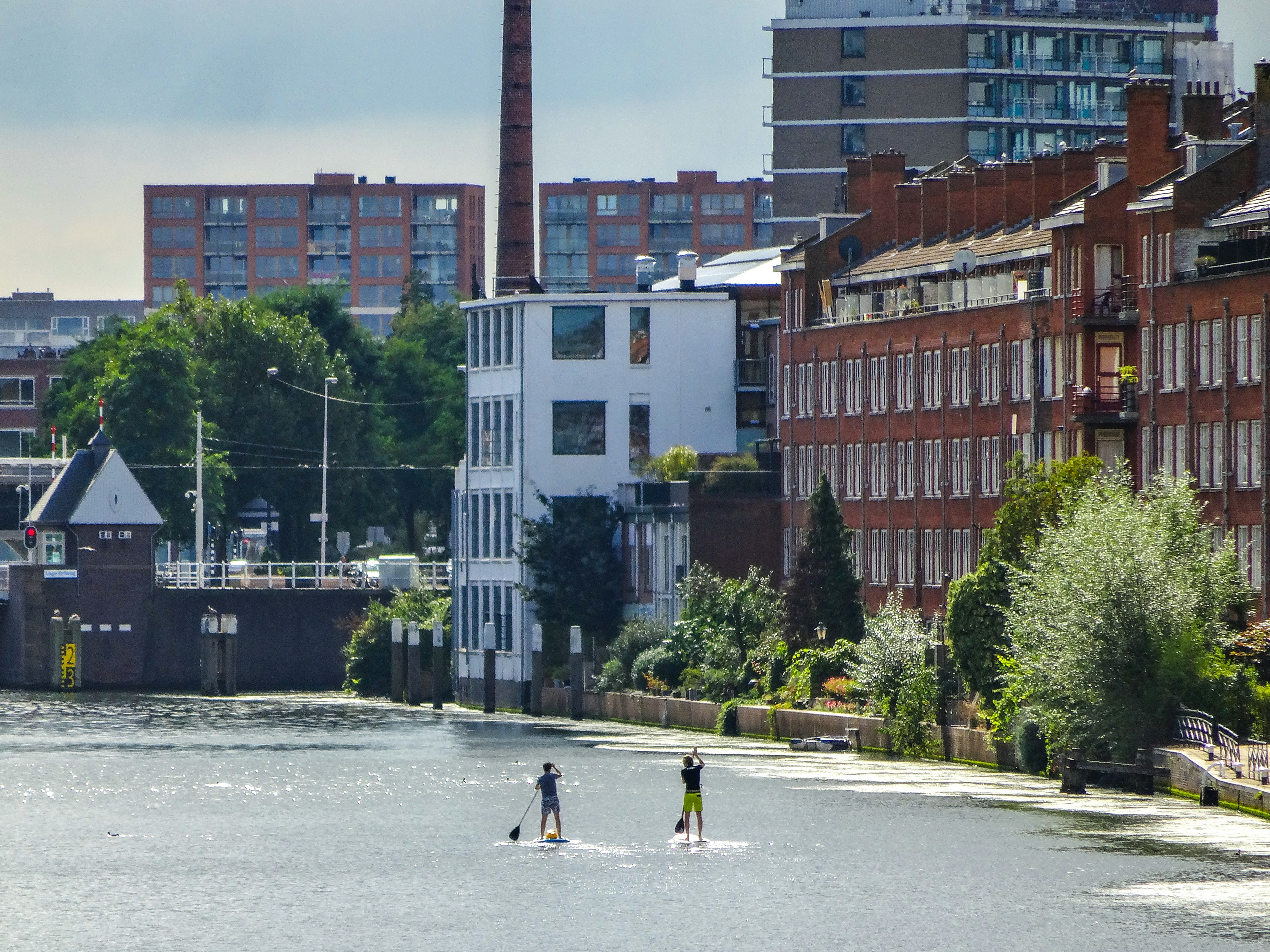 Riverside Balancing Act: Stand-Up Paddlers Against an Urban Wake