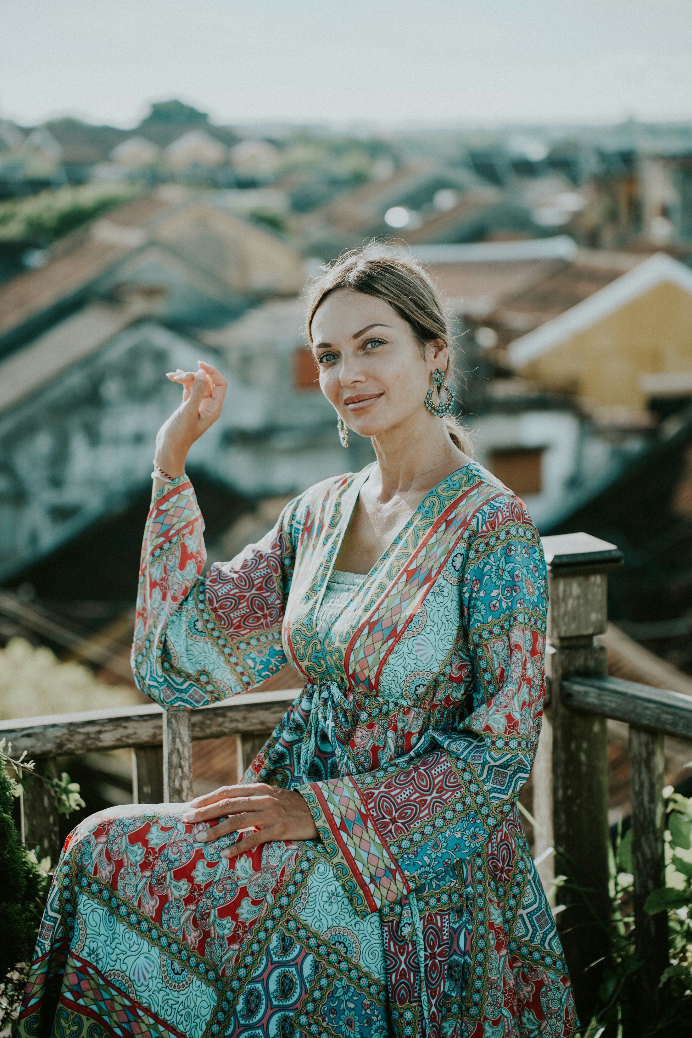 Portrait on a Sunlit Terrace: A Poised Moment in Colorful Bohemian Garb
