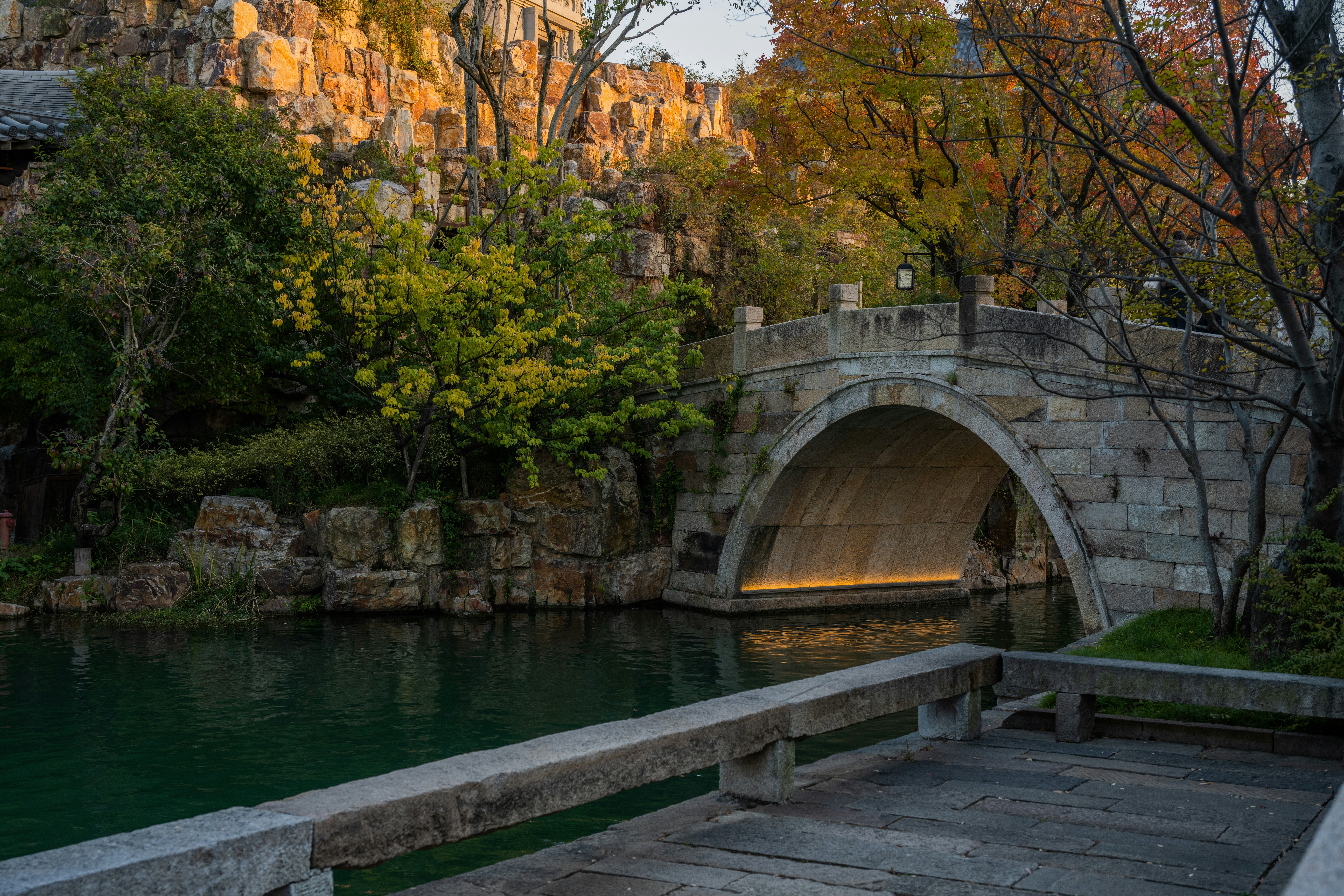 Stone Bridge Over Quiet Aquamarine Waters at Golden Hour