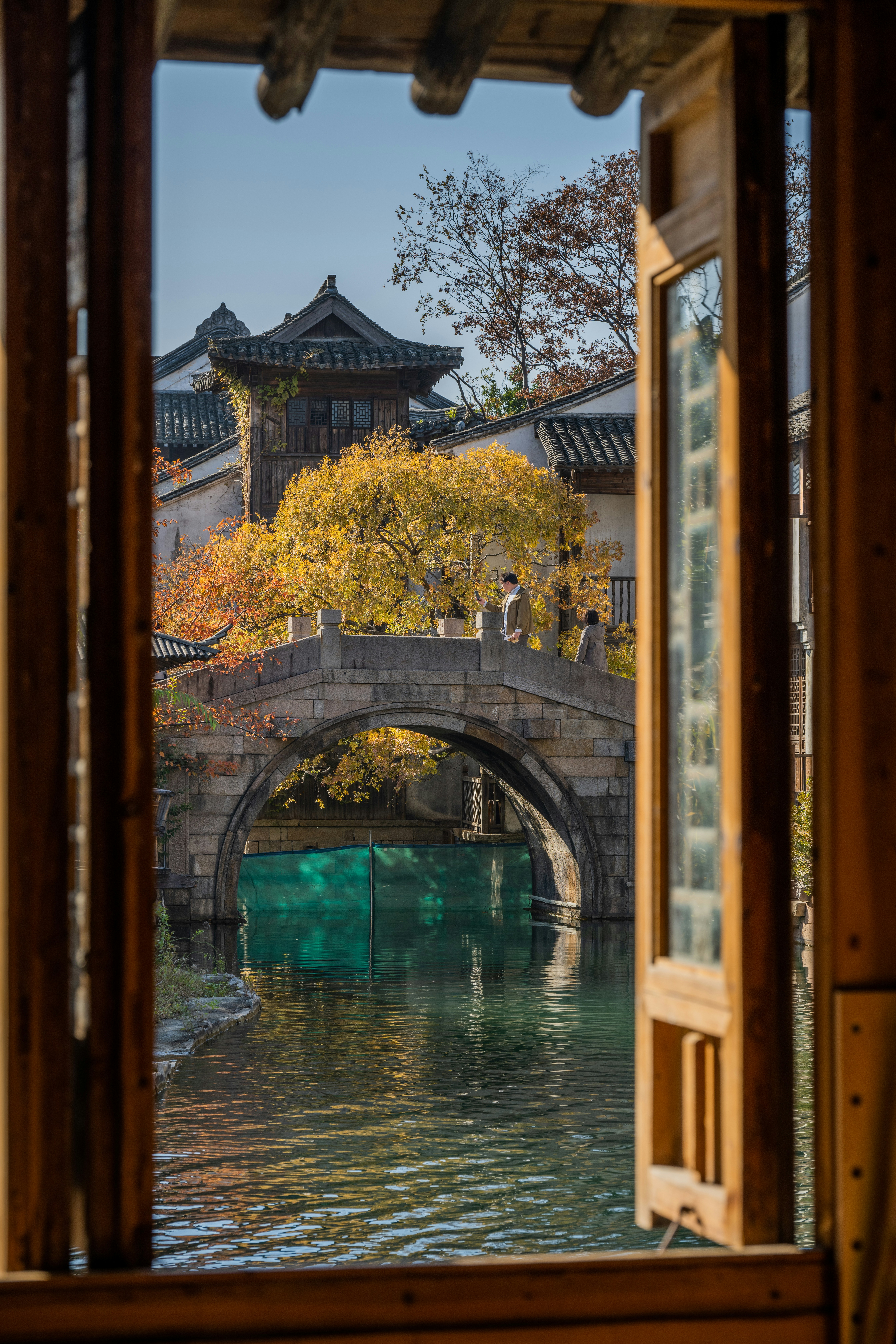 Autumn Bridge Framed by Wooden Doors
