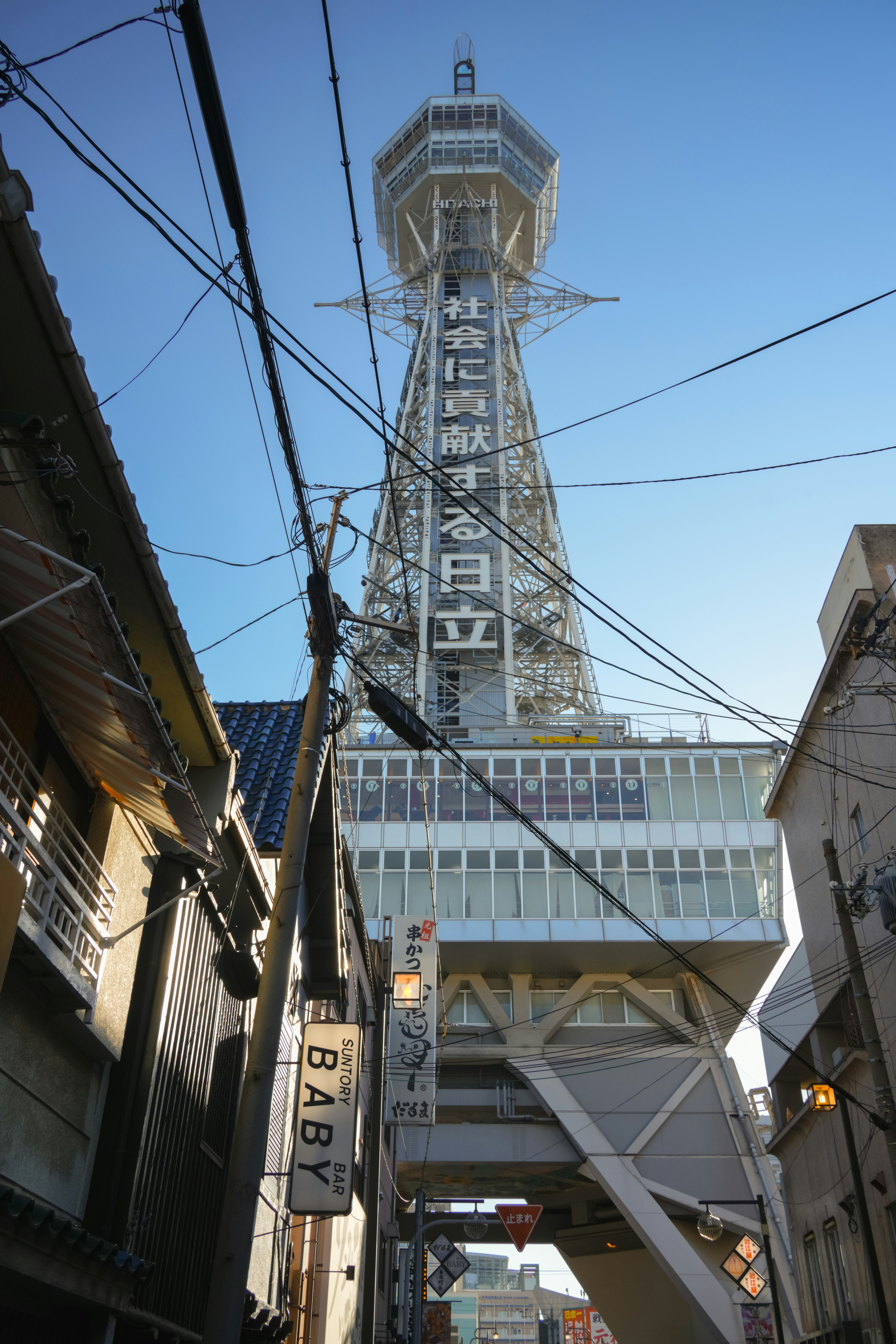 Towering Promenade: A Narrow Street Leads to the City’s Signpost