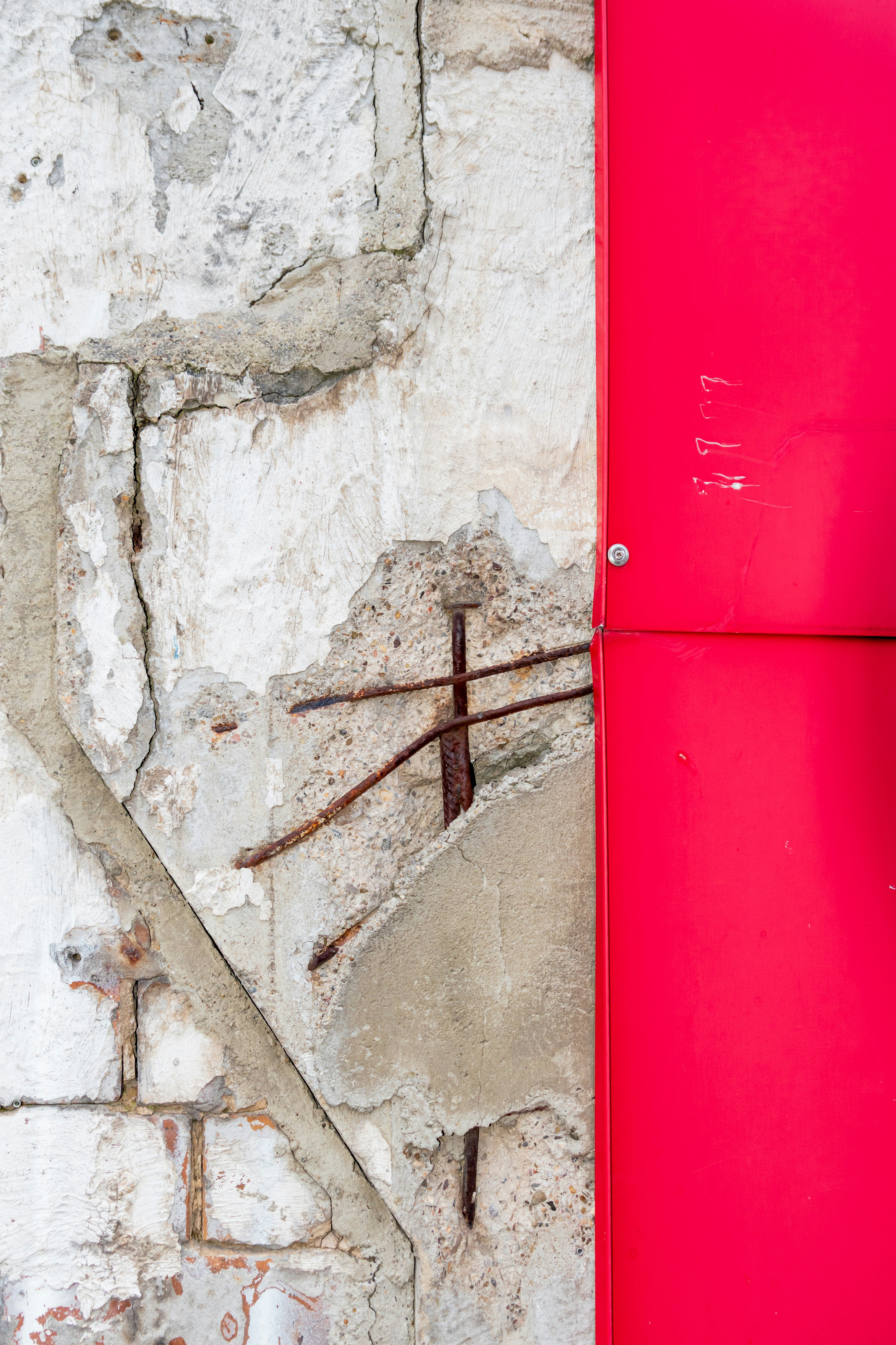 Cracked Concrete Meets Bright Red Panel