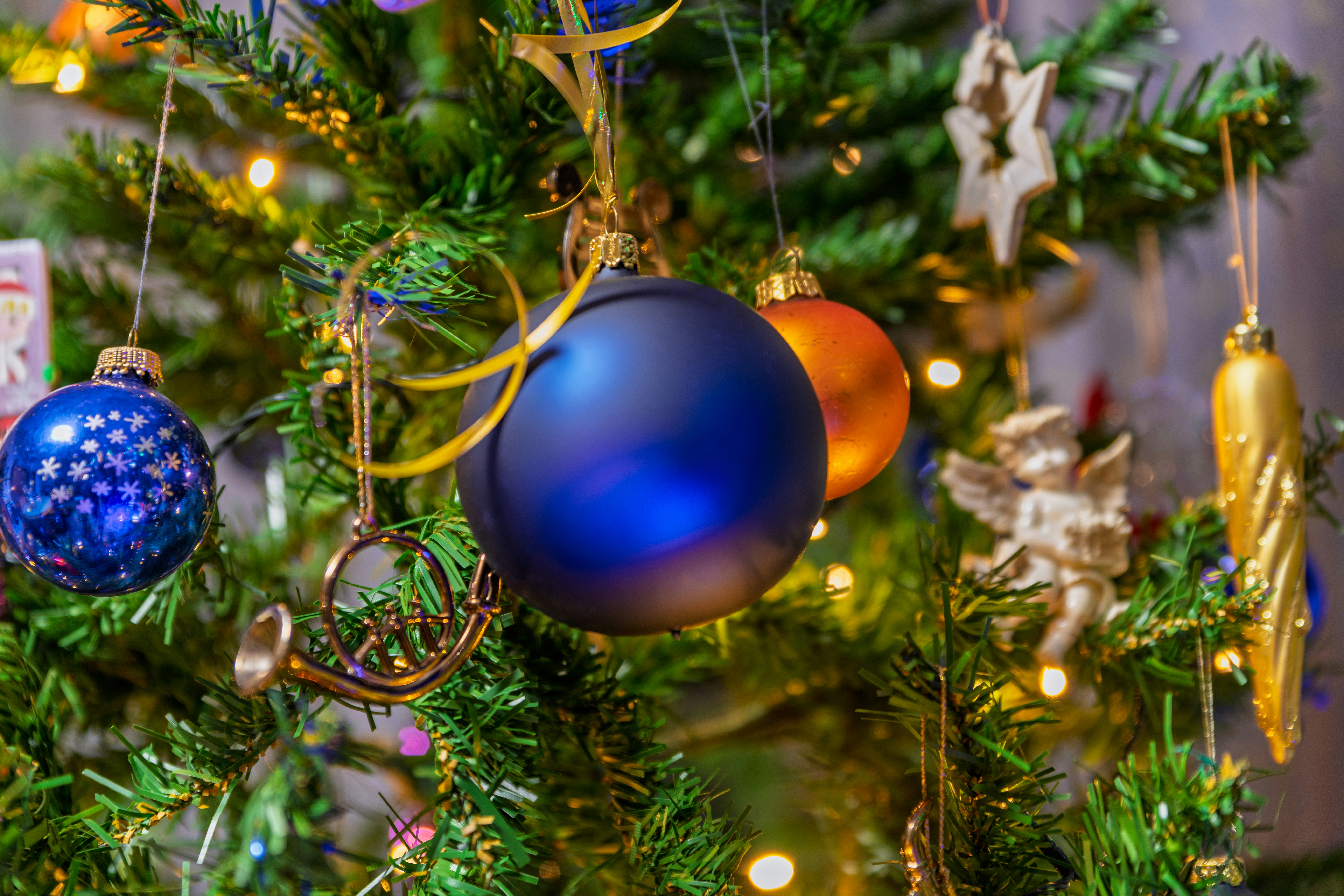 Blue orb among gold and green: a festive close-up of Christmas ornaments