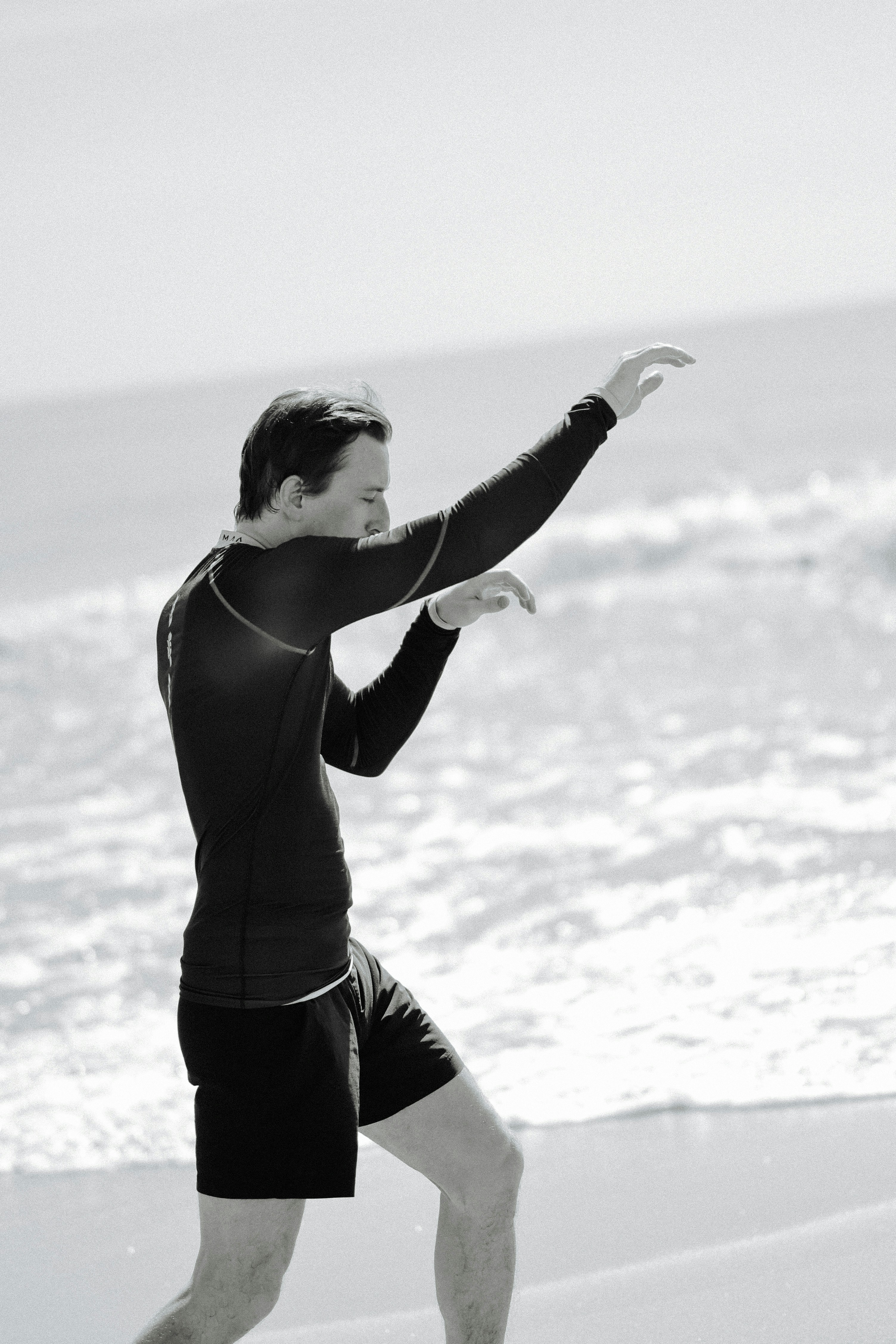 Beachbound Motion: A Surfer in Black