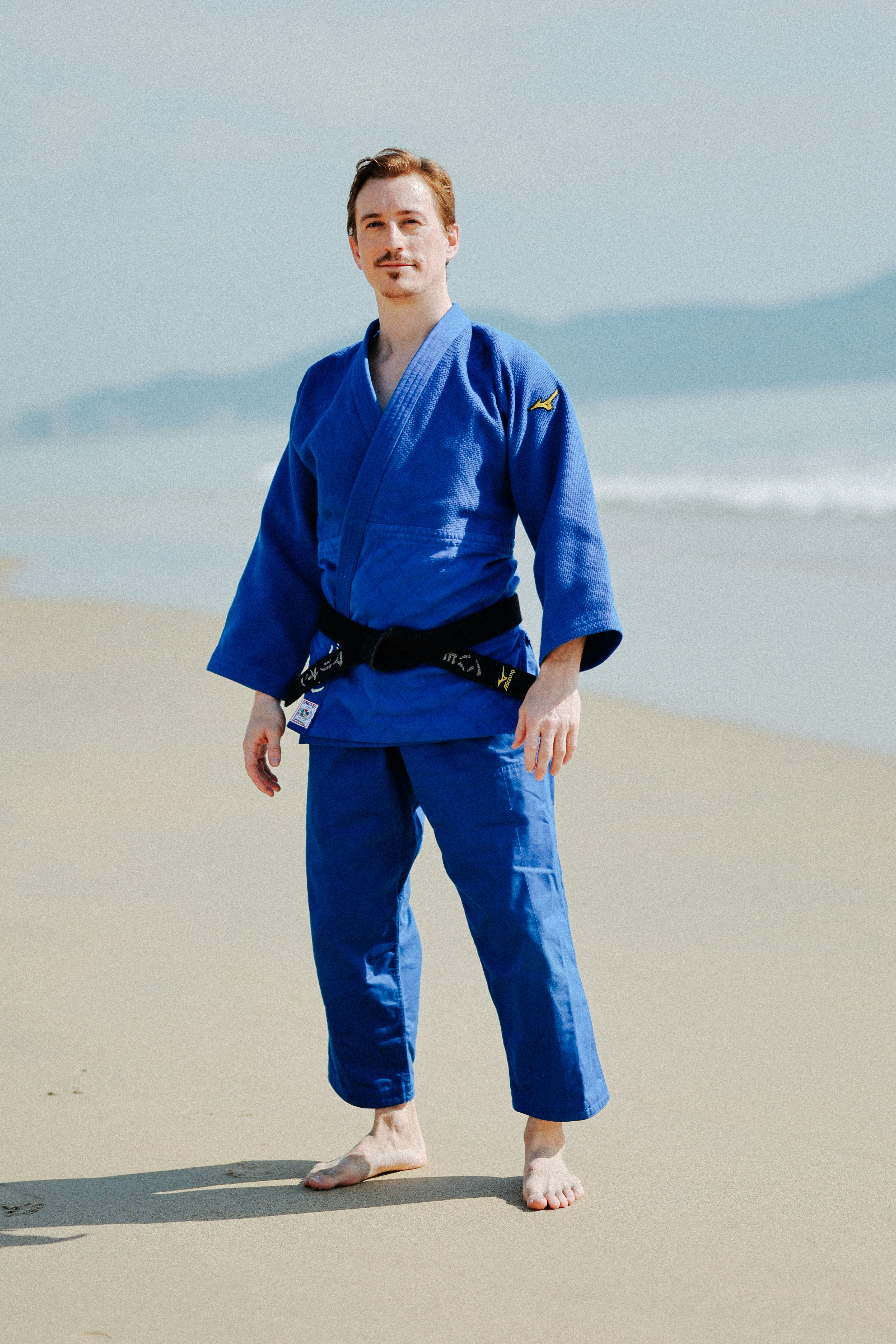 Man in blue judo uniform on a sandy beach. photo – Free Beach Image on ...