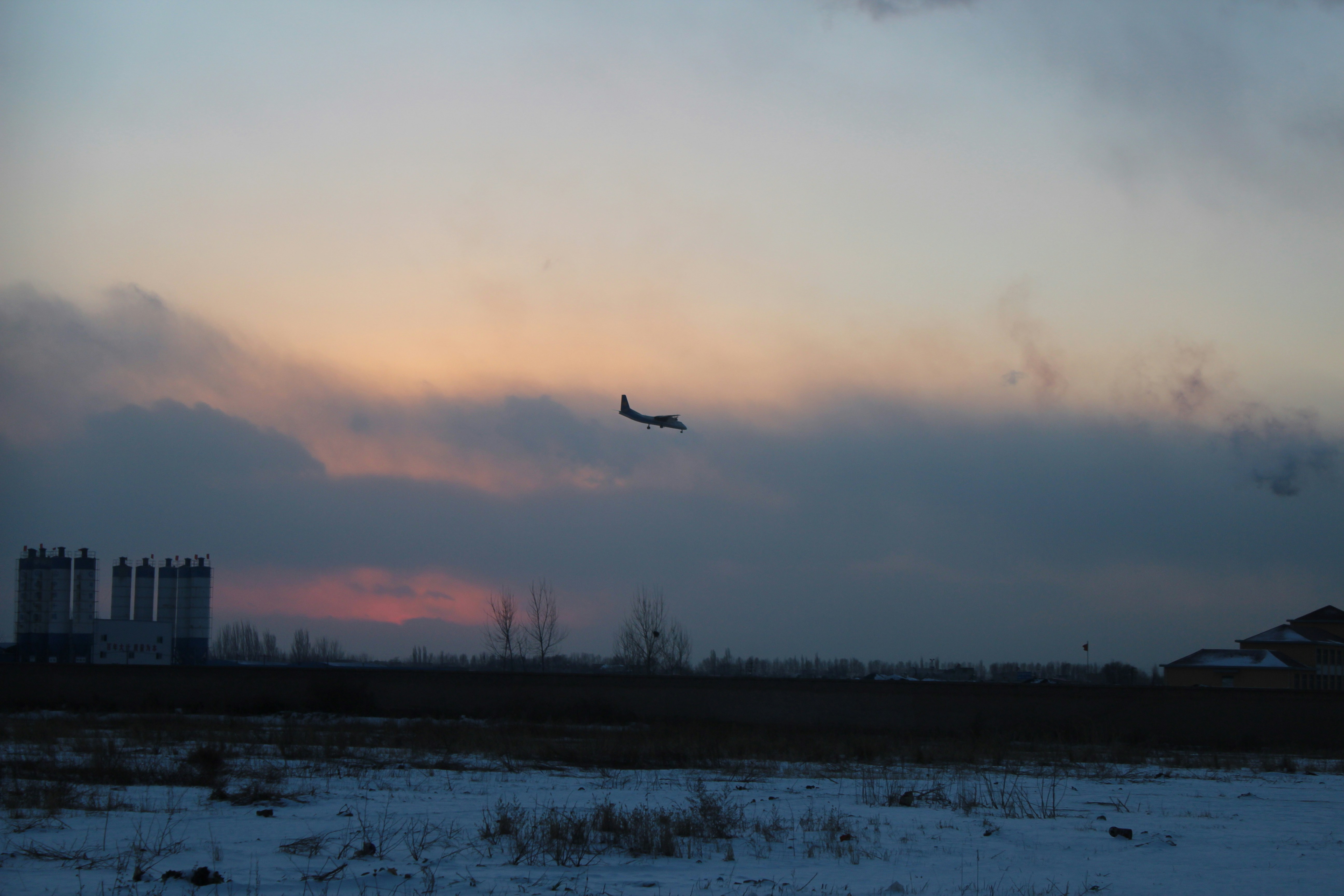 Dawn Break: A lone airplane skim the waking horizon