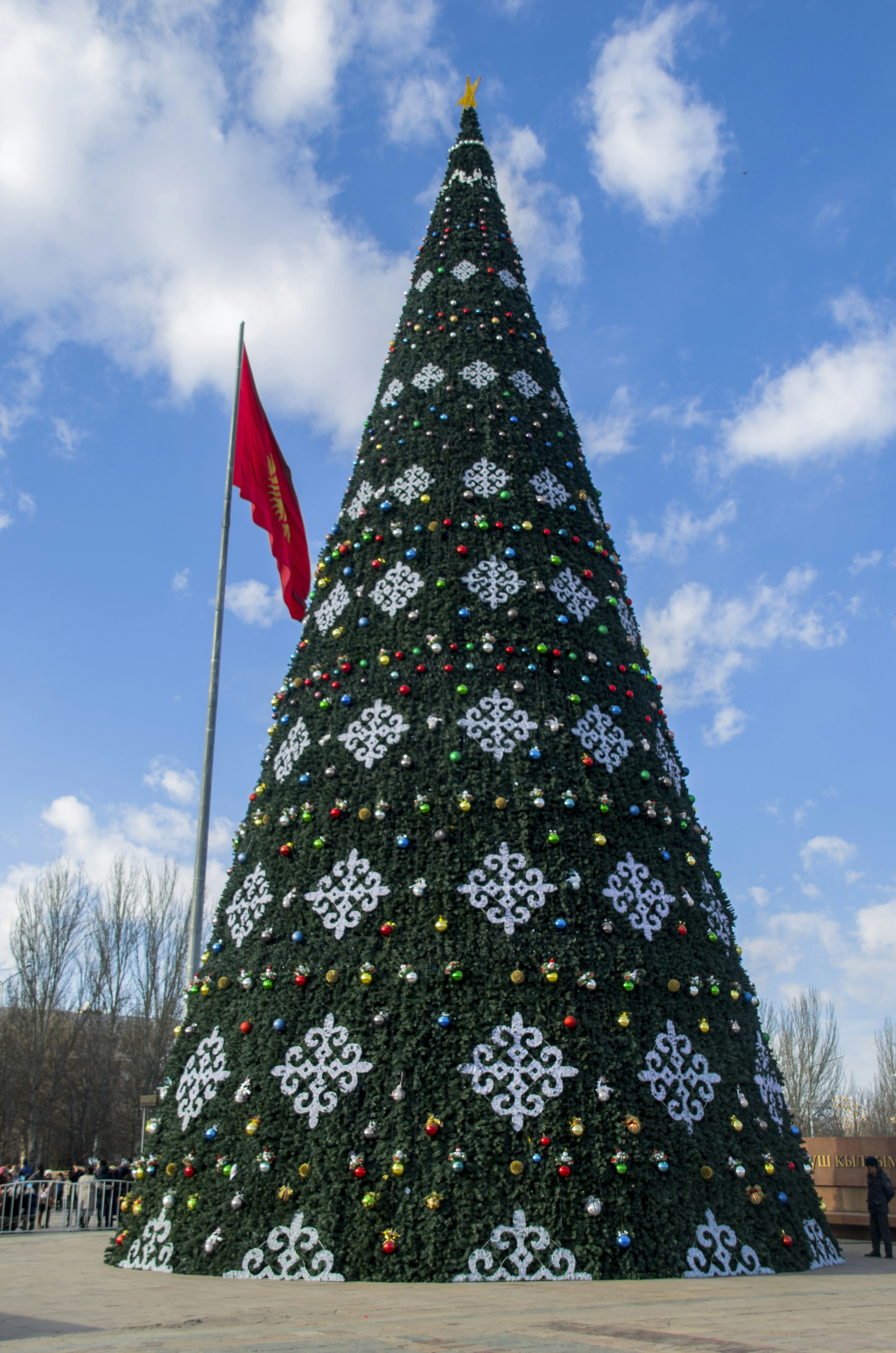 Towering Ornament: A Holiday Tree Reaches Toward a Sky of Blue