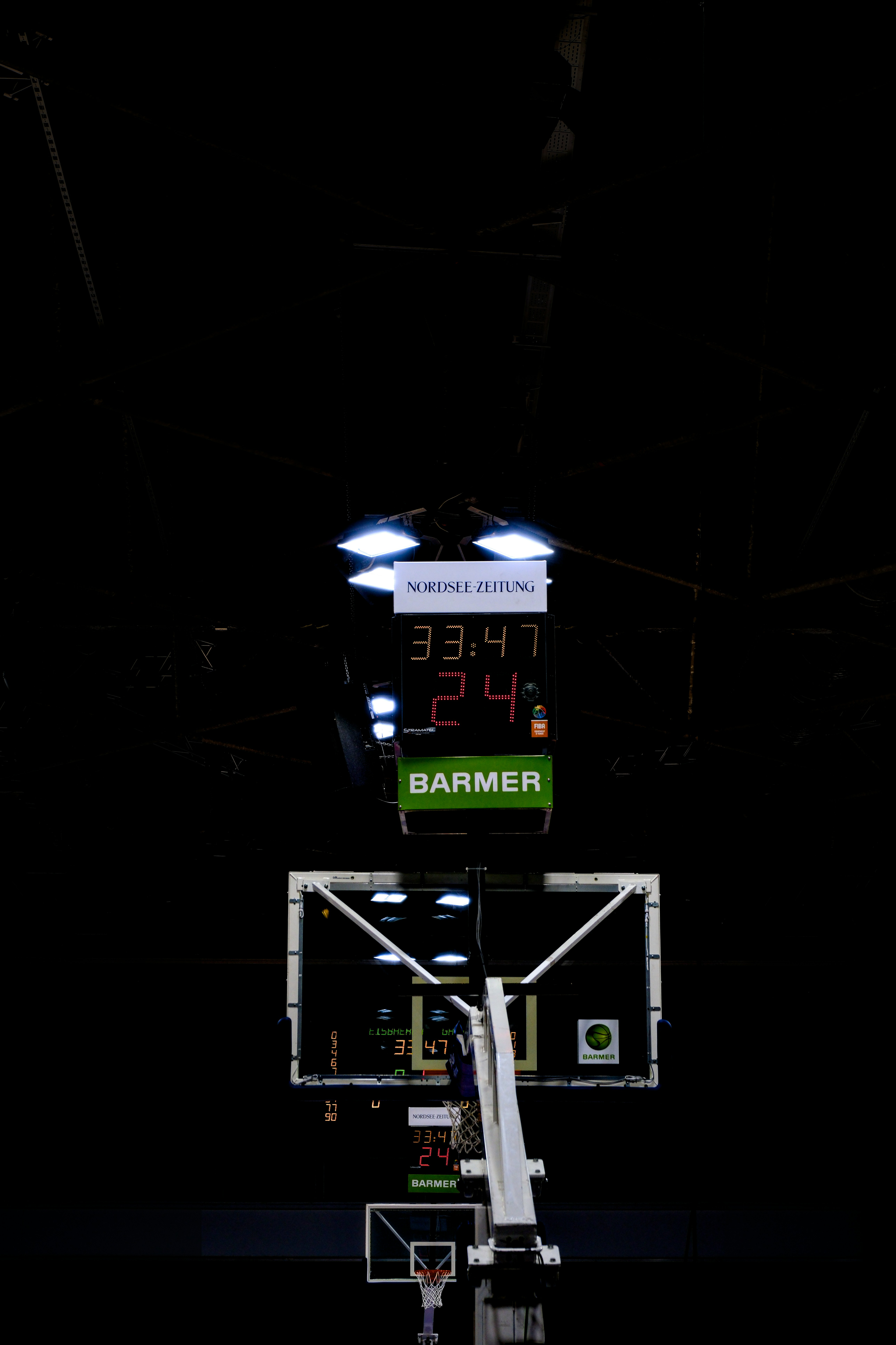 Nighttime Basketball Timer in a Dim Arena