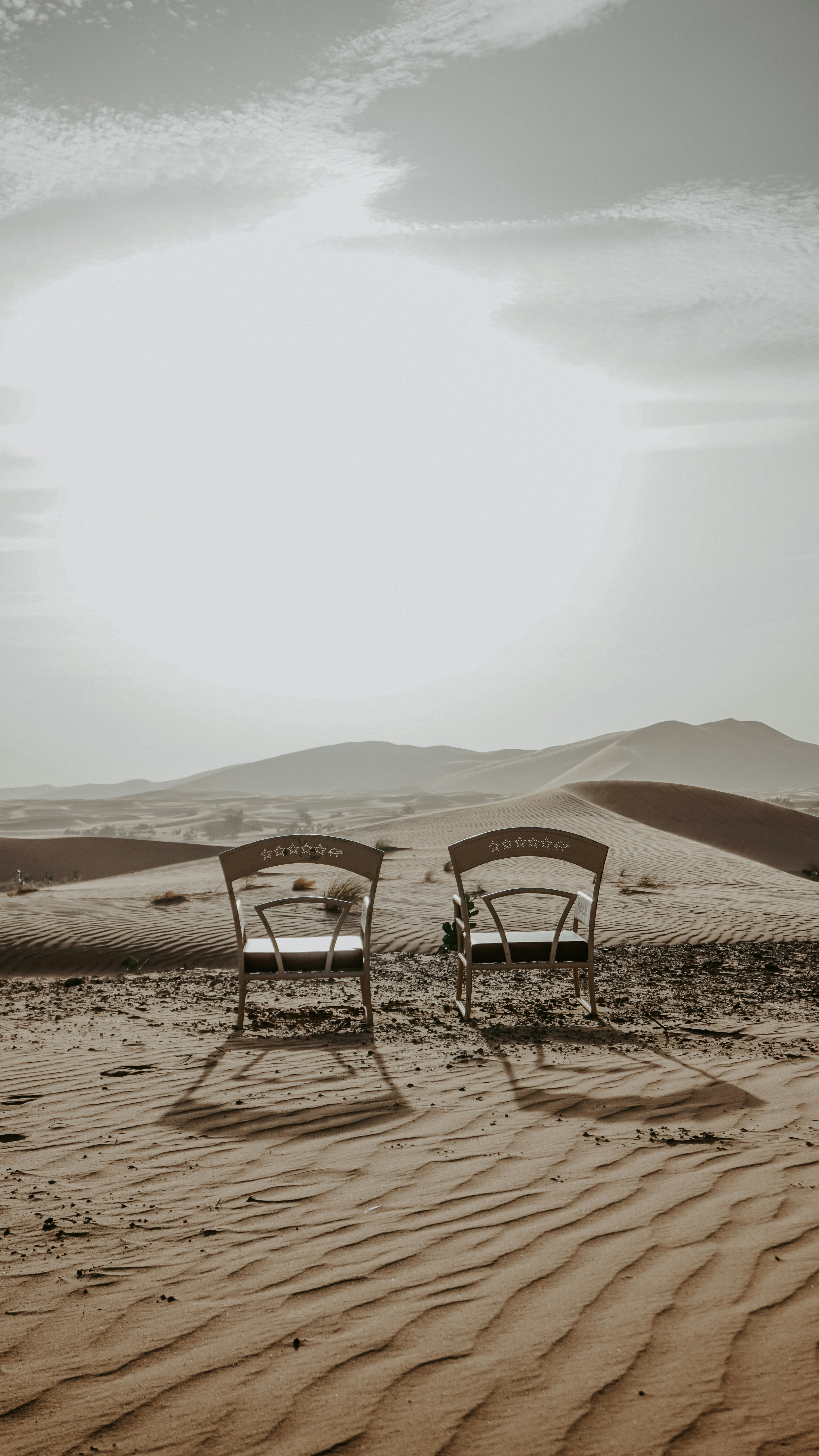 Desert Chairs at Dusk: Two Seats amid Endless Dunes
