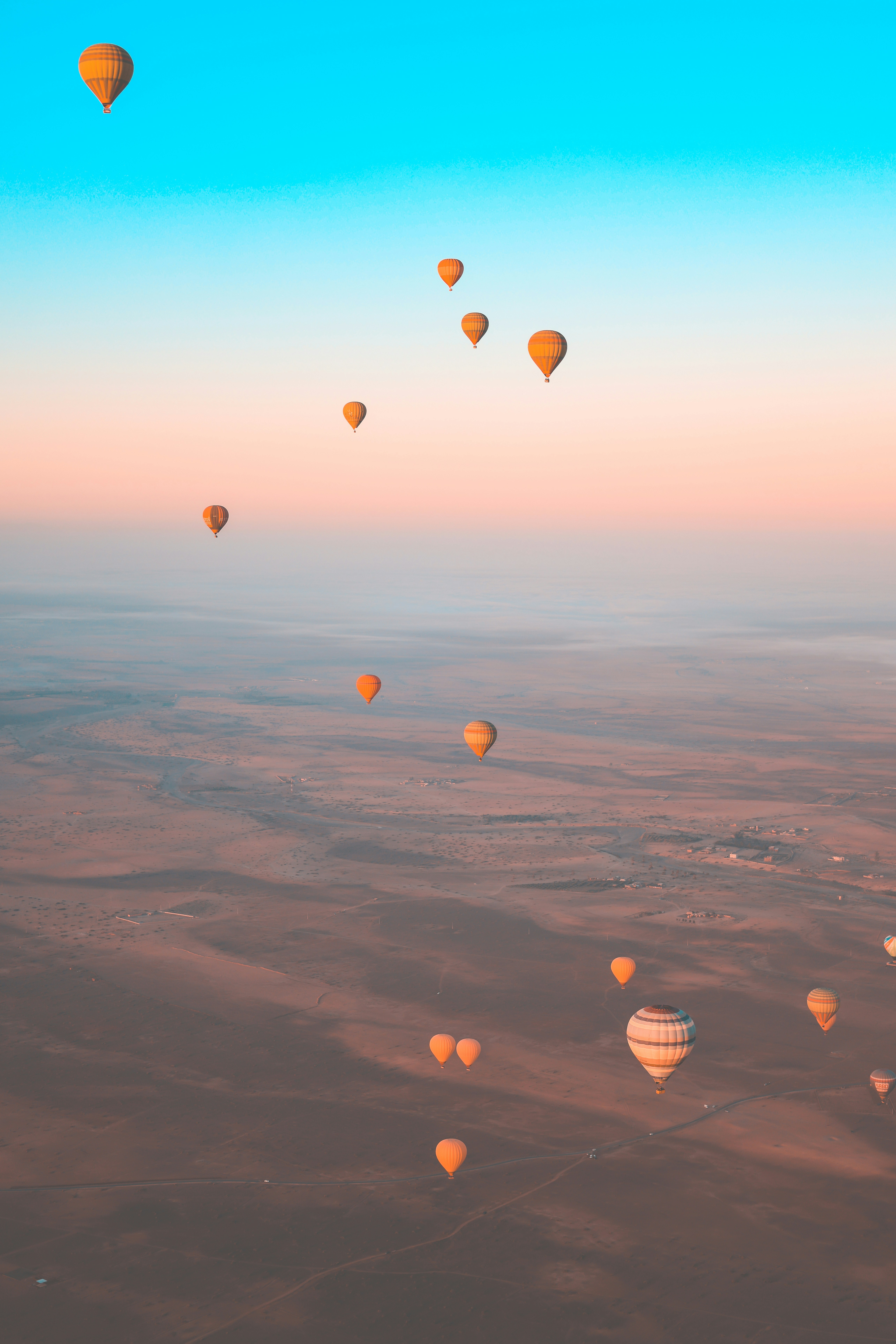 Vast Sky Chorus: A Scout of Orange Balloons Across Awakening Velvet Dawn