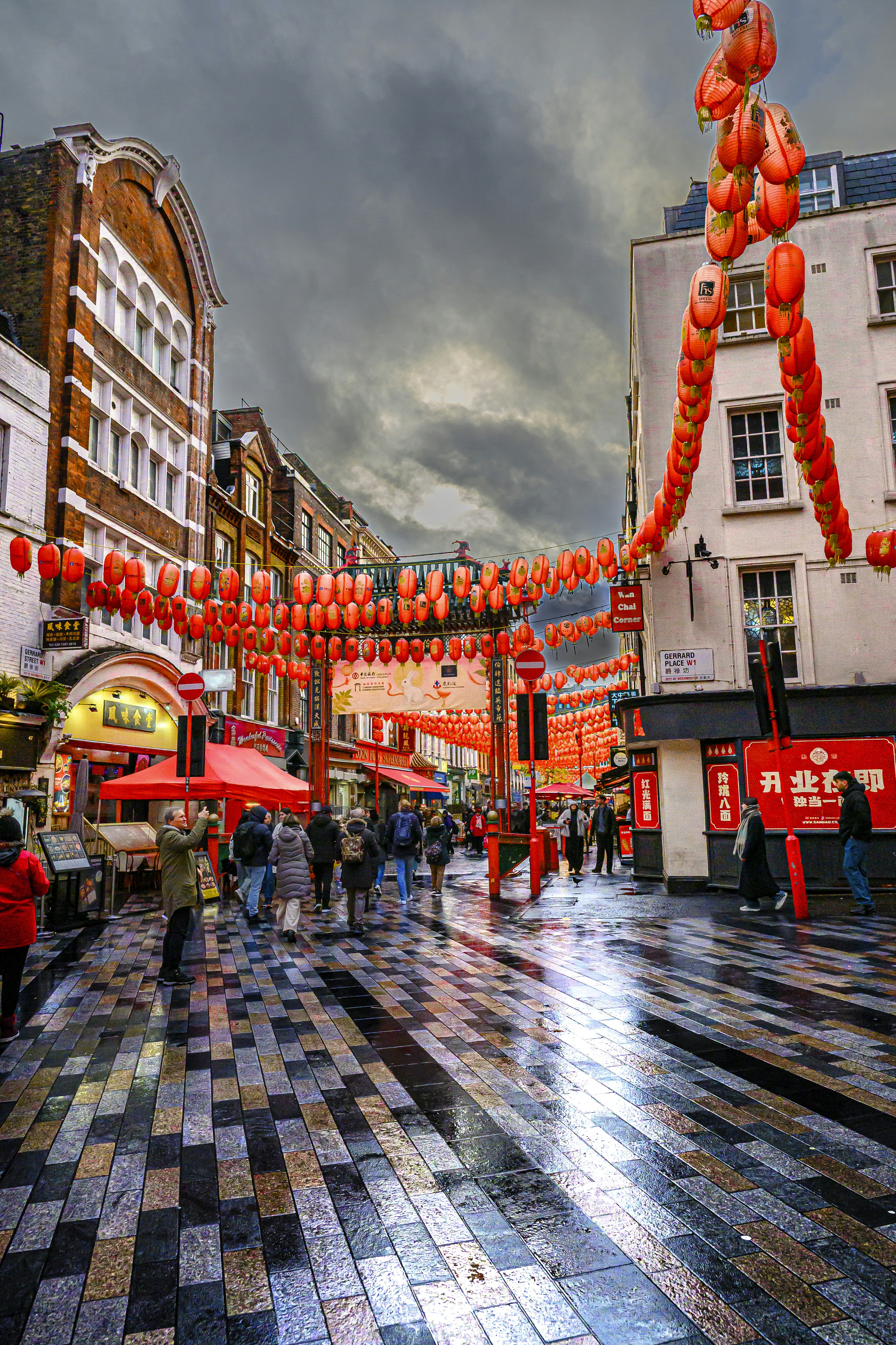 Lantern Night Market: Red Orbs Weaving Through a Cloudy Street