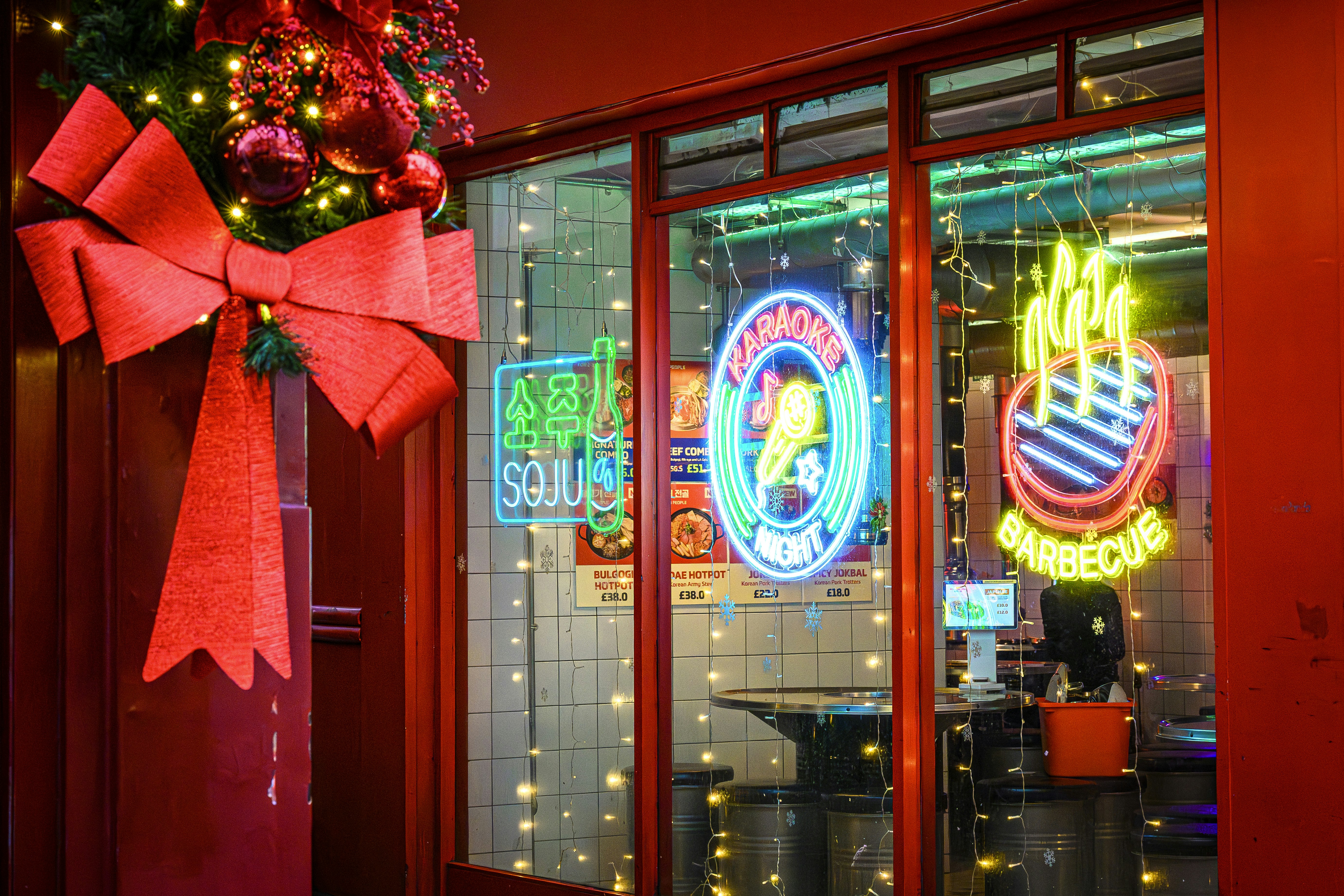 Neon Holiday Corner: Red Ribbon and Colorful Lights at the Diner Window