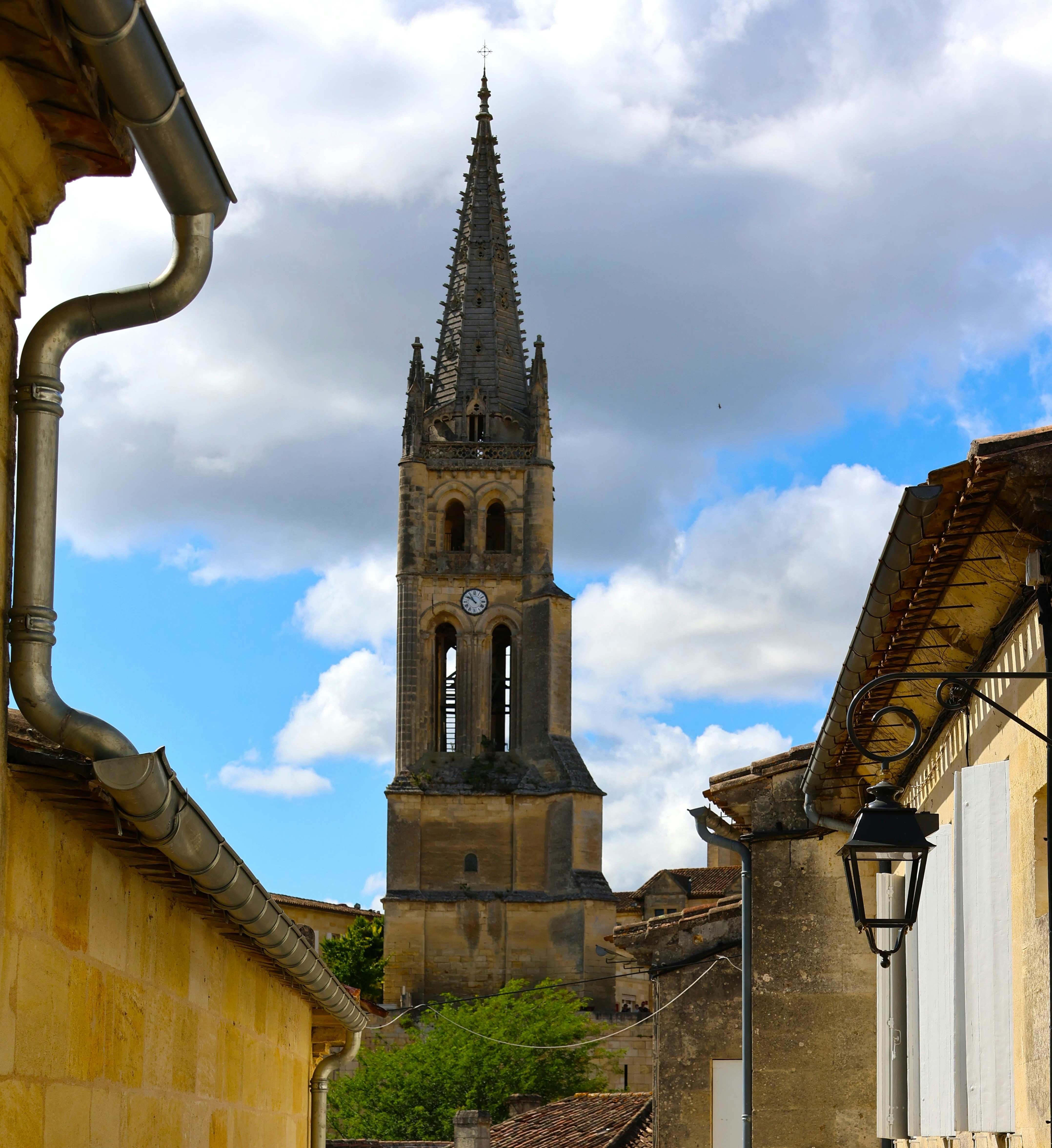Steeple in an Old Town: A Narrow Street Framing a Gothic Clocktower