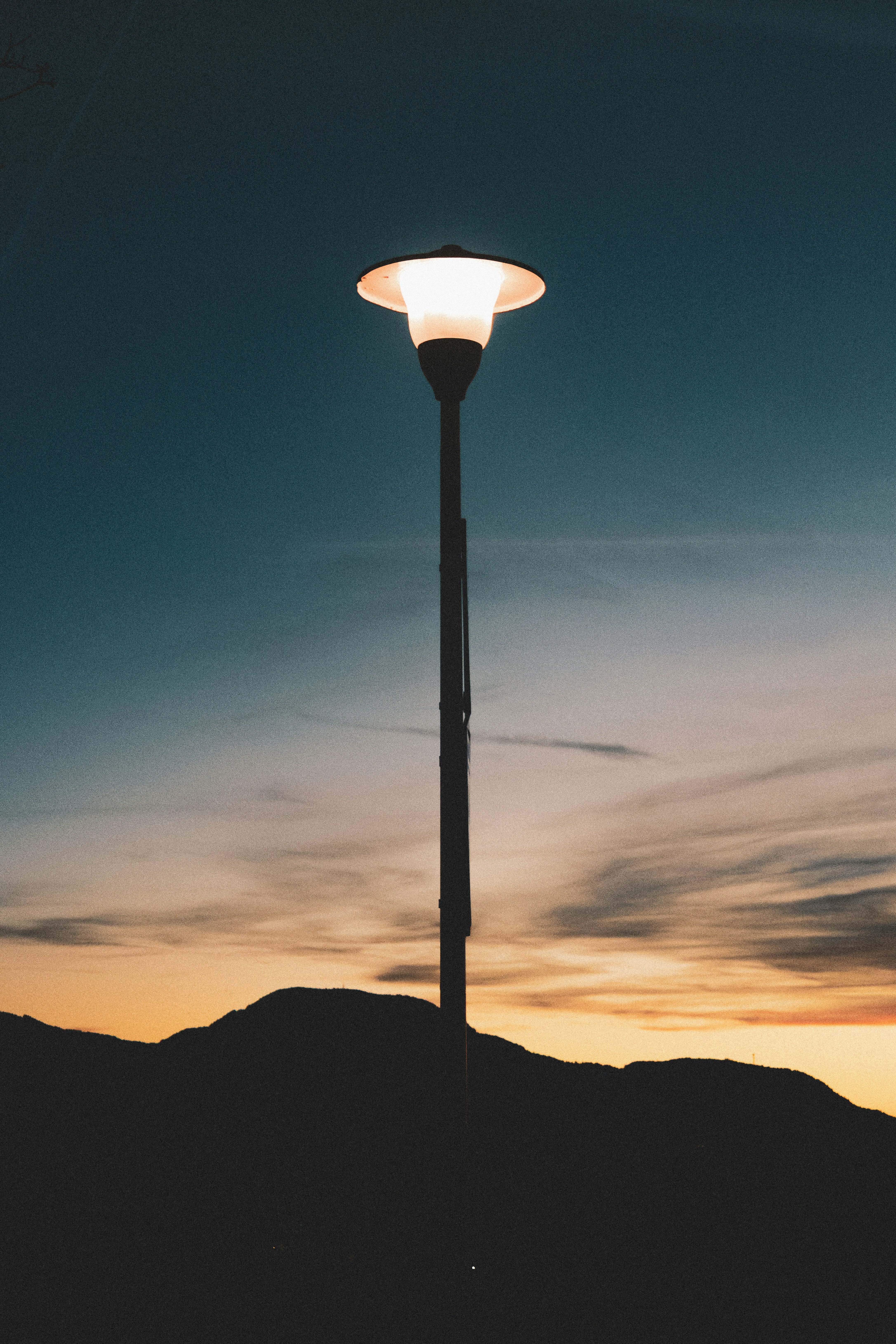Lamp Post at Dusk: A solitary beacon above the horizon