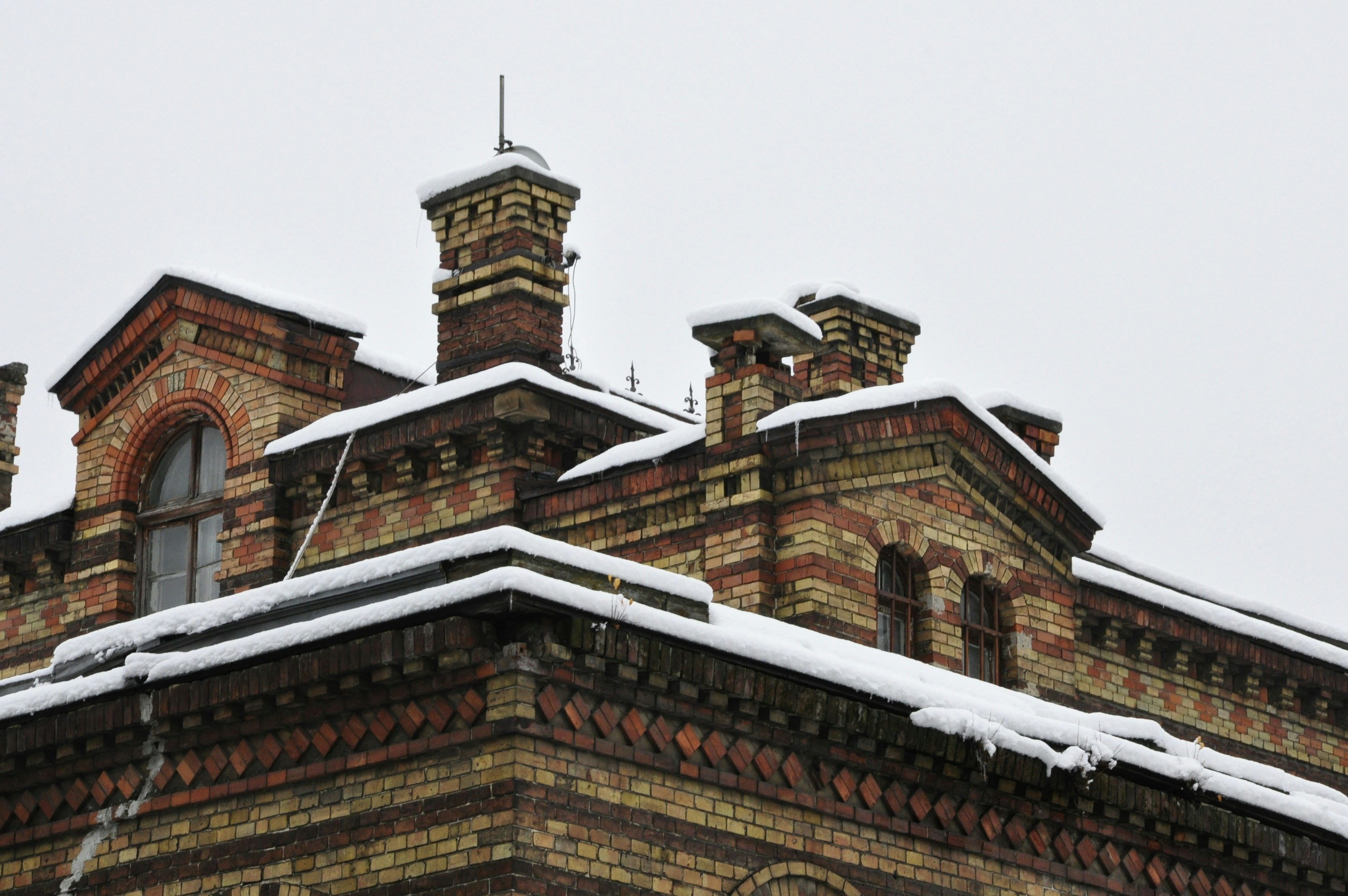 Snow on the Brick Turrets: A Quiet Rooftop Corner