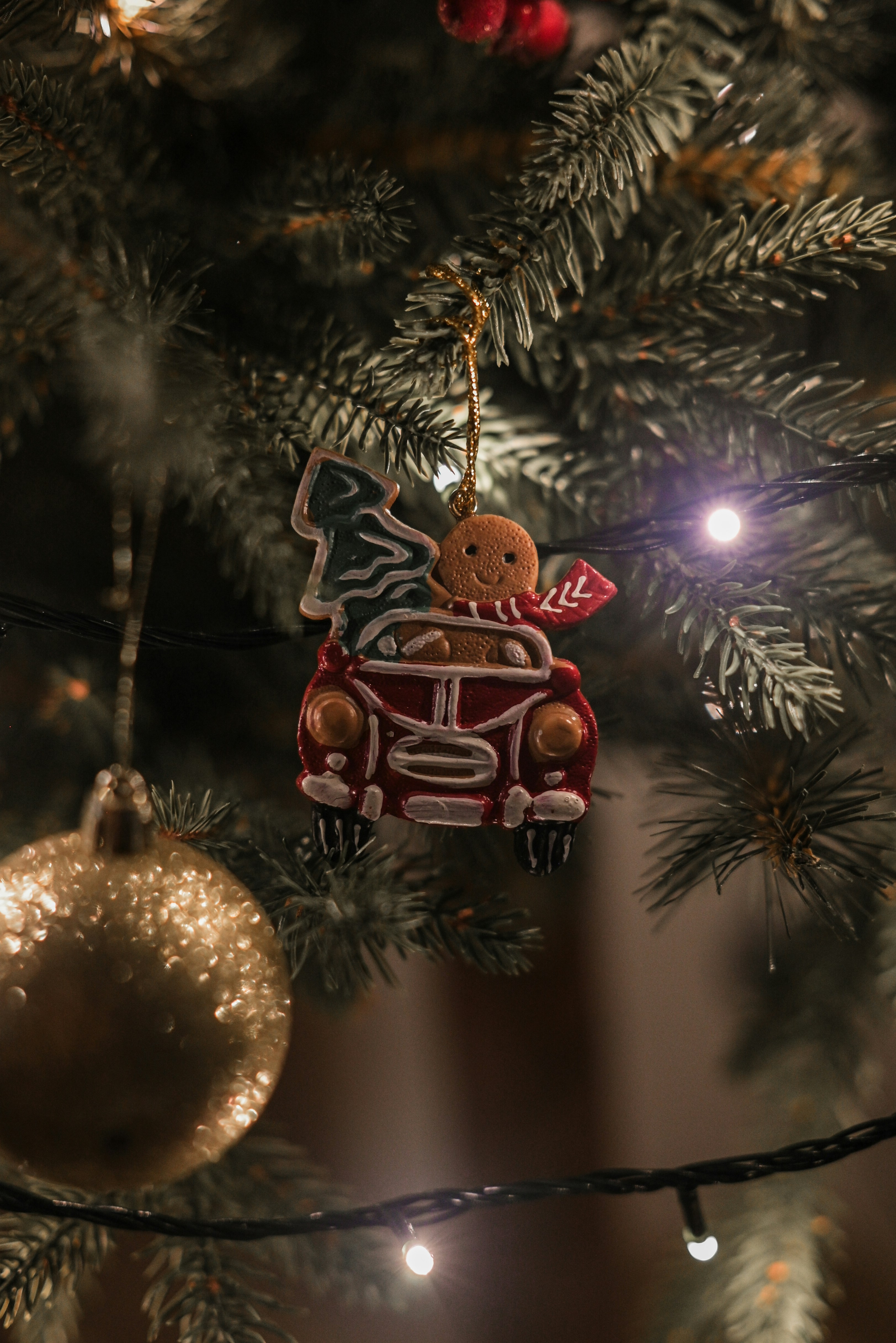 Gingerbread Car Ornament Dangles Amid Christmas Lights