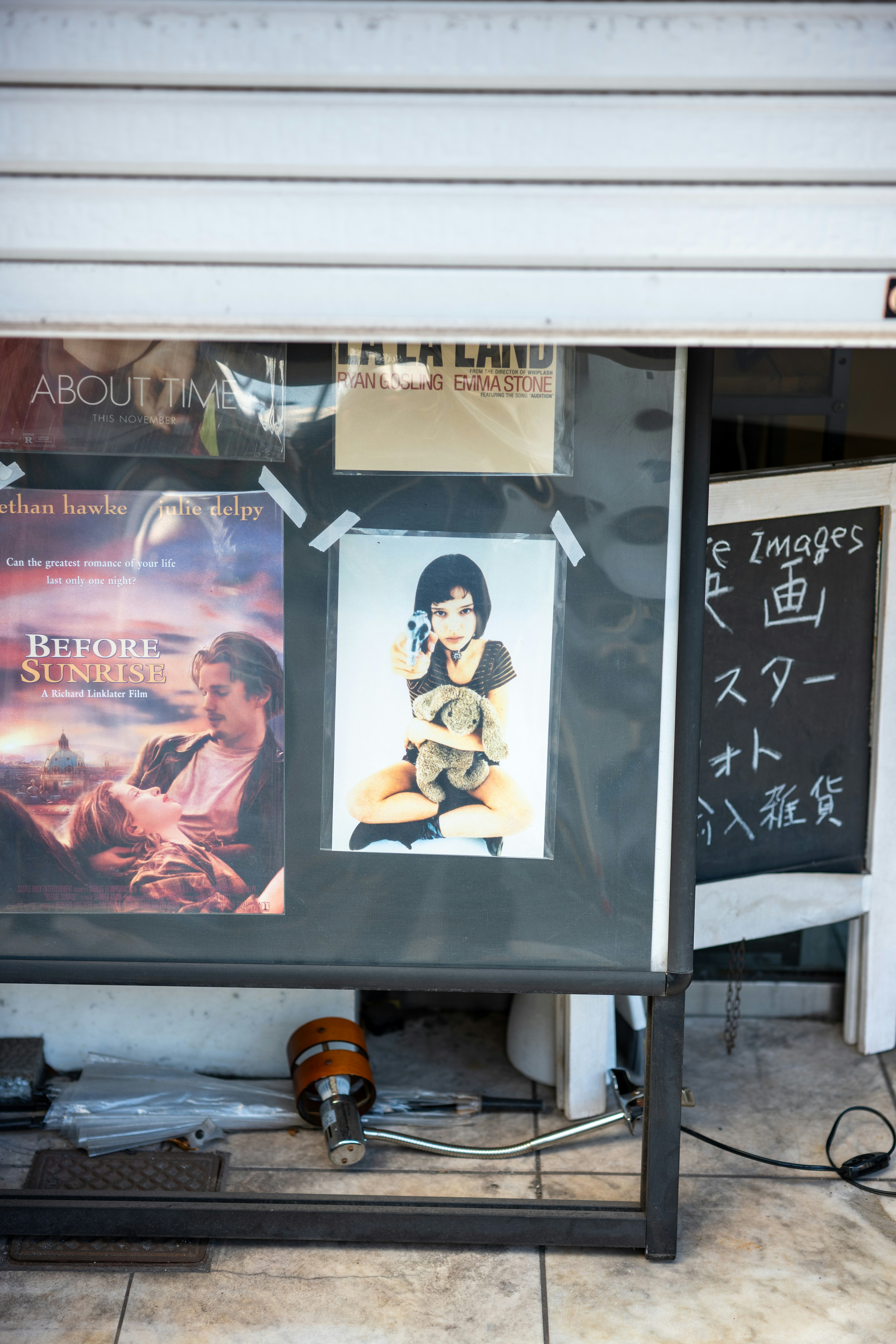 Poster Wall with Center Portrait Anchoring a Street Display